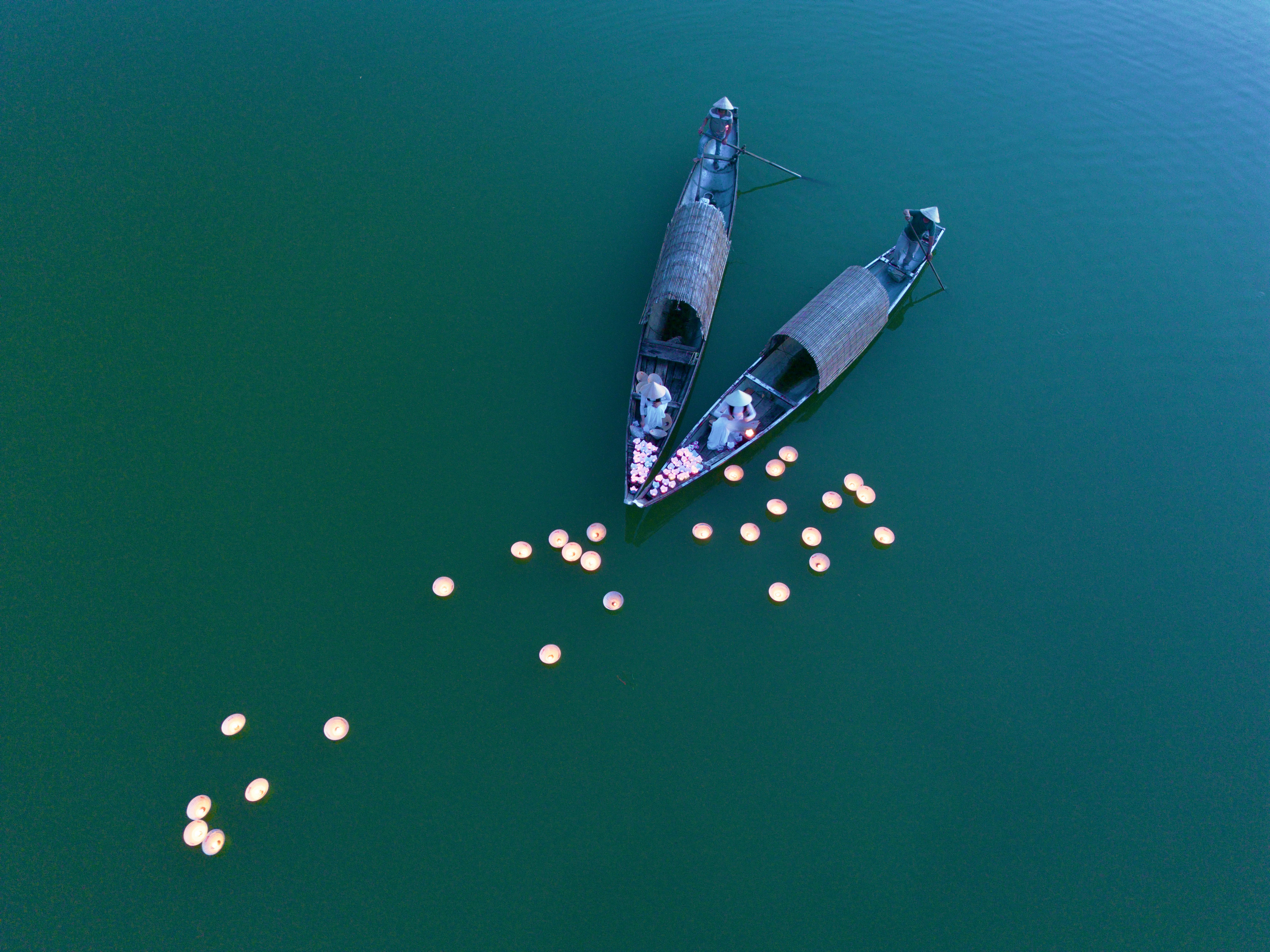 Aerial View of Boats with Floating Candles on Water · Free Stock Photo