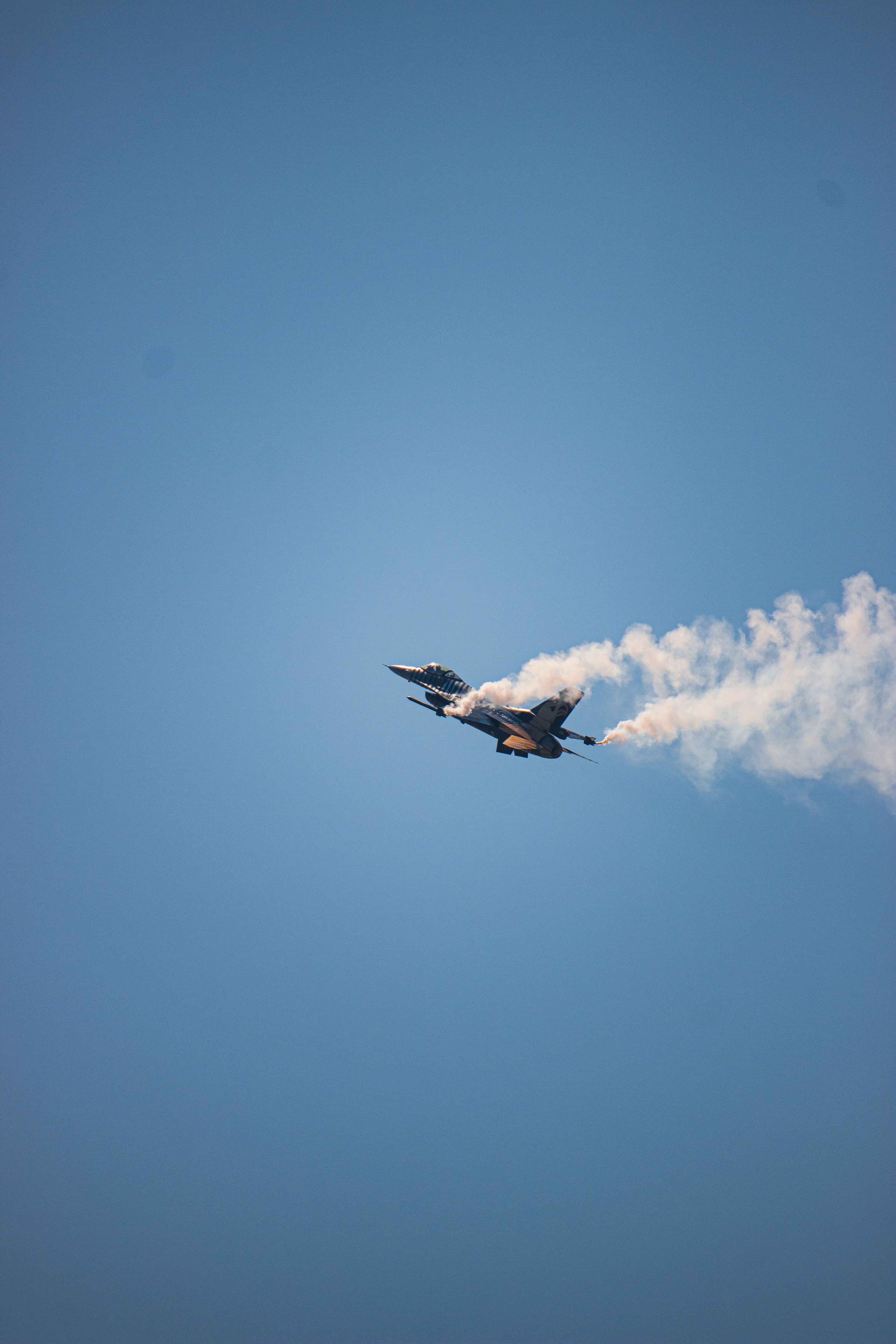 Jet Fighter Performing Aerobatic Maneuver in Clear Sky · Free Stock Photo
