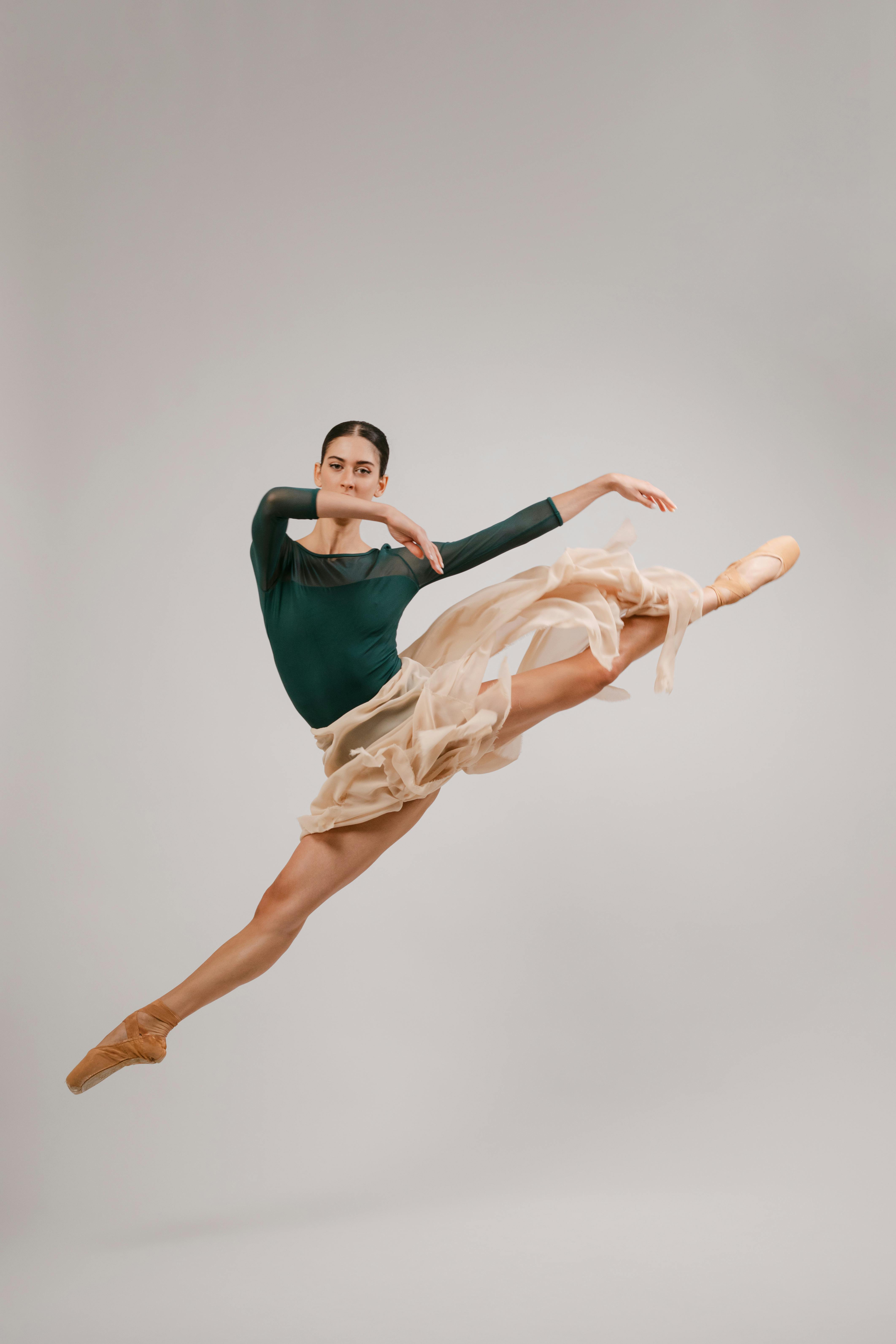 Graceful Ballerina in Mid-Air Leap Captured · Free Stock Photo