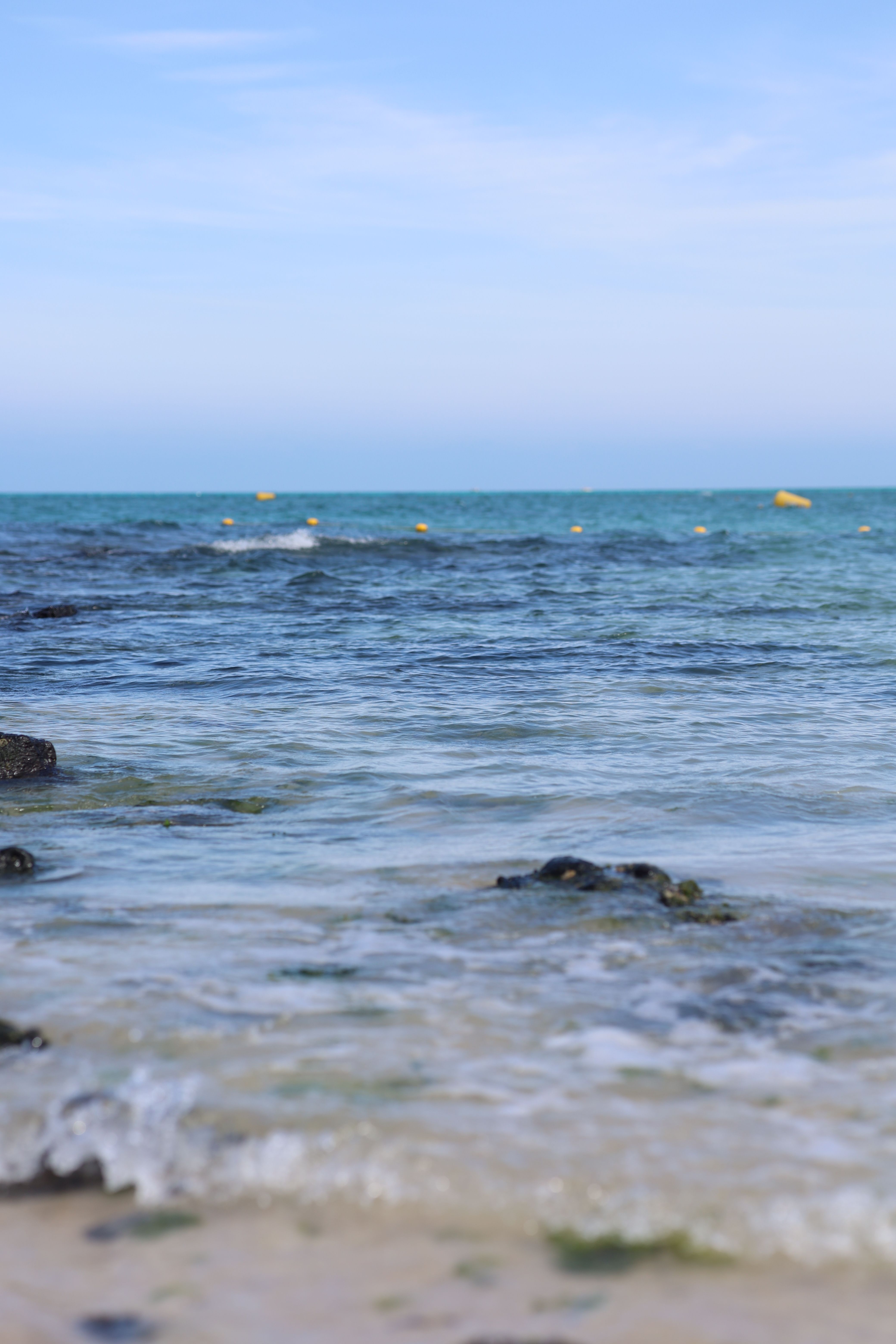 Tranquil Ocean Waves Lapping at Rocky Shore · Free Stock Photo