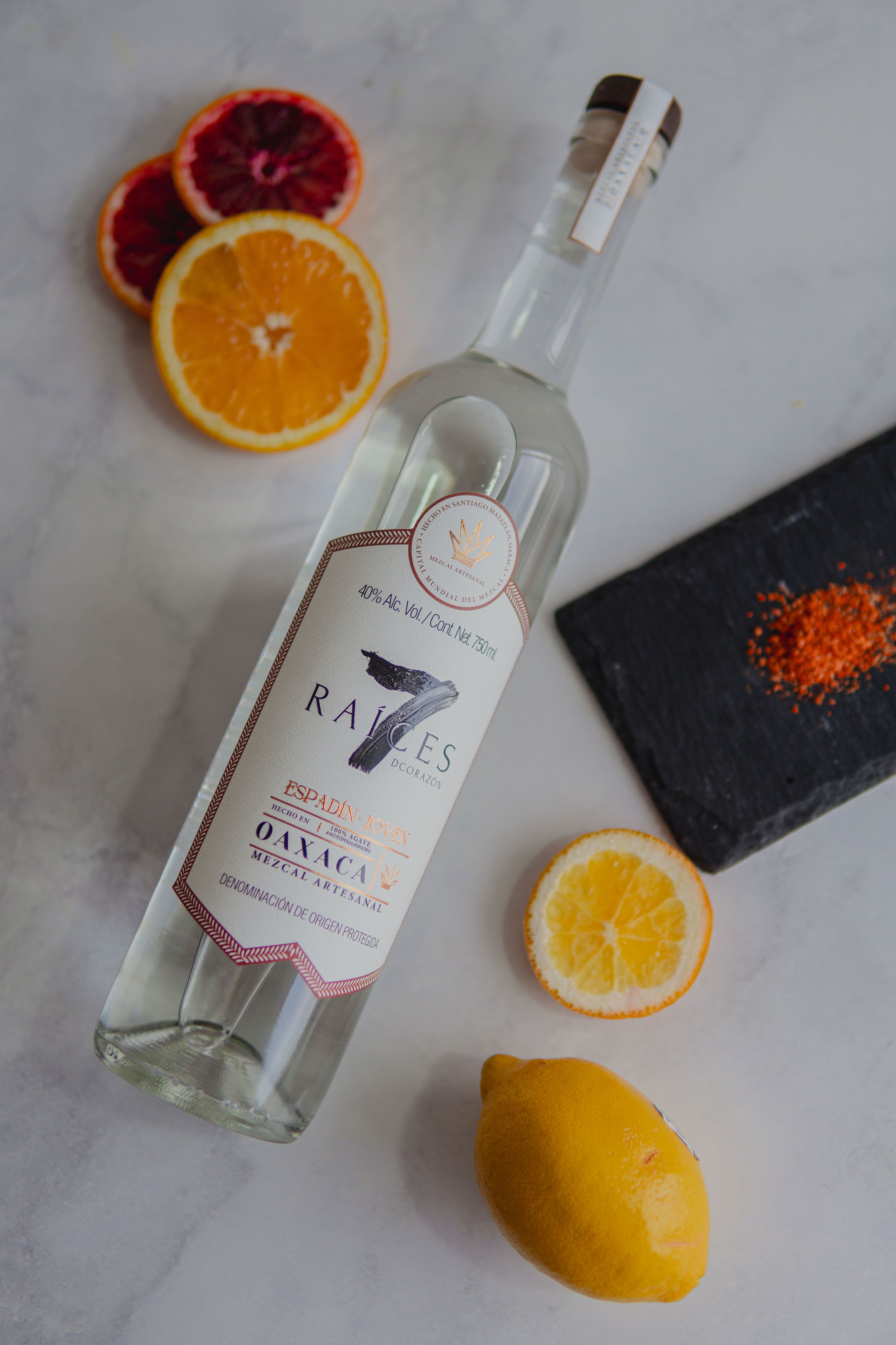 Artistic Mezcal Bottle with Fresh Citrus · Free Stock Photo