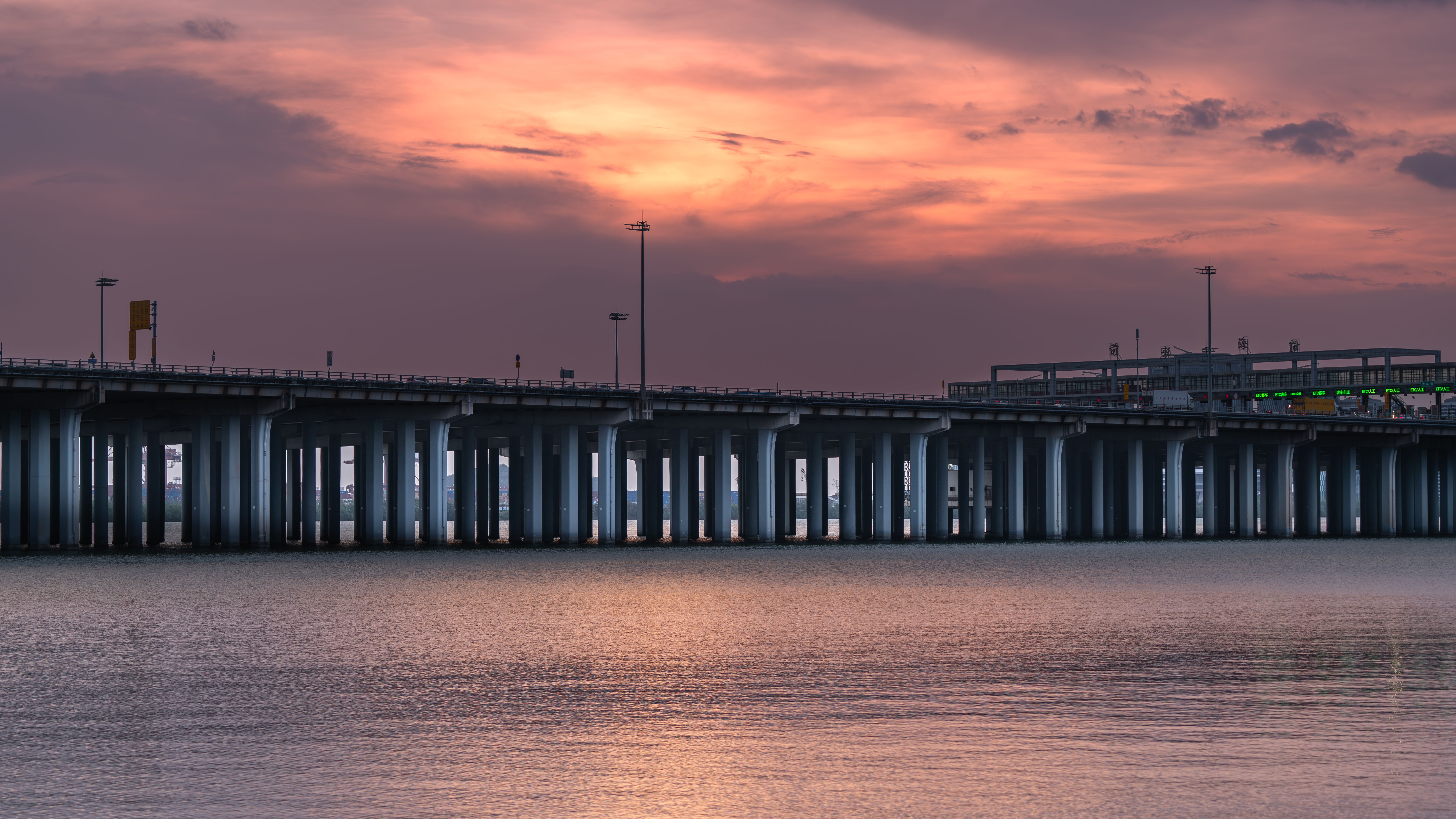 Scenic Bridge at Sunset Over Calm Waters · Free Stock Photo