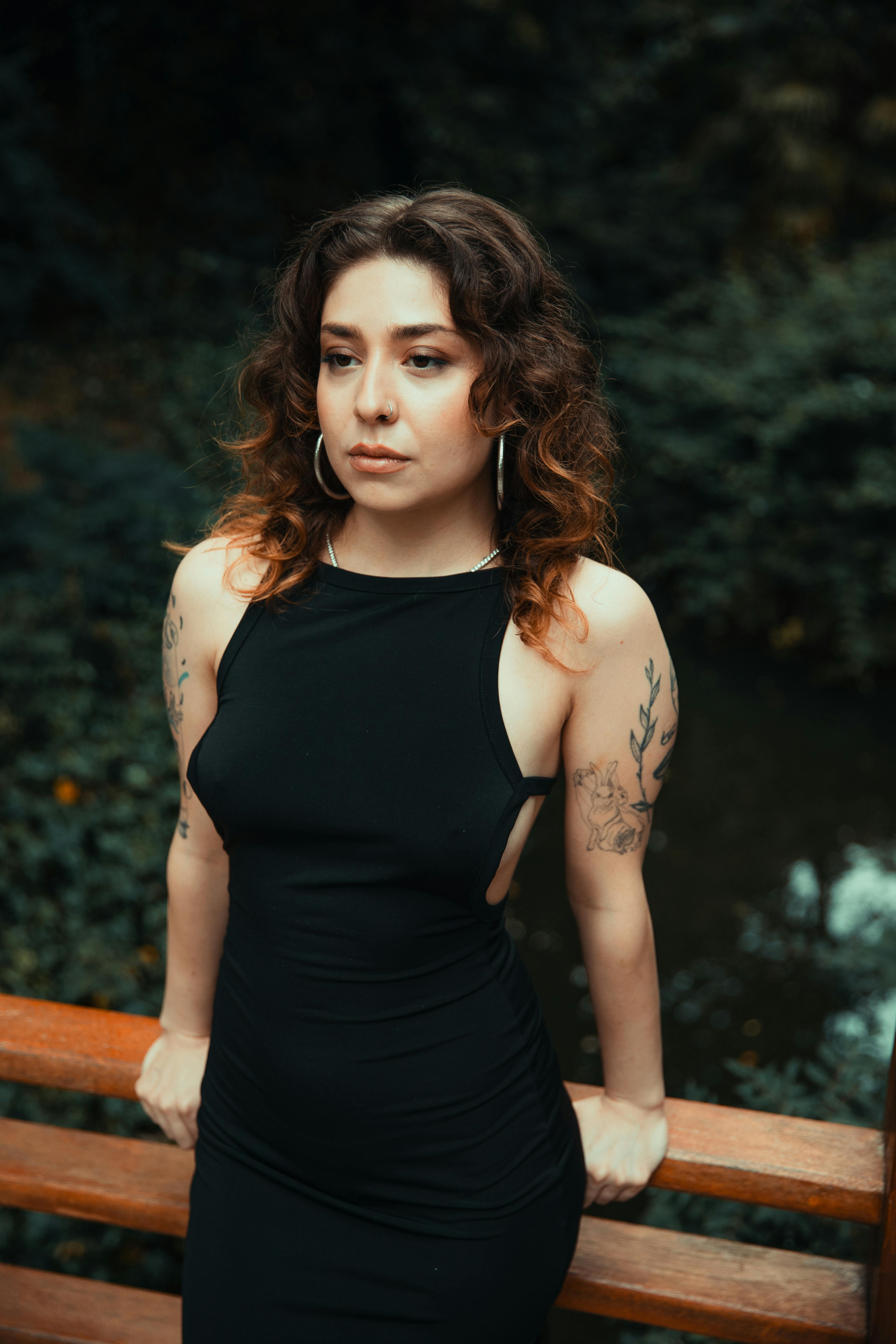 Stylish Woman in Black Dress on Wooden Bridge · Free Stock Photo