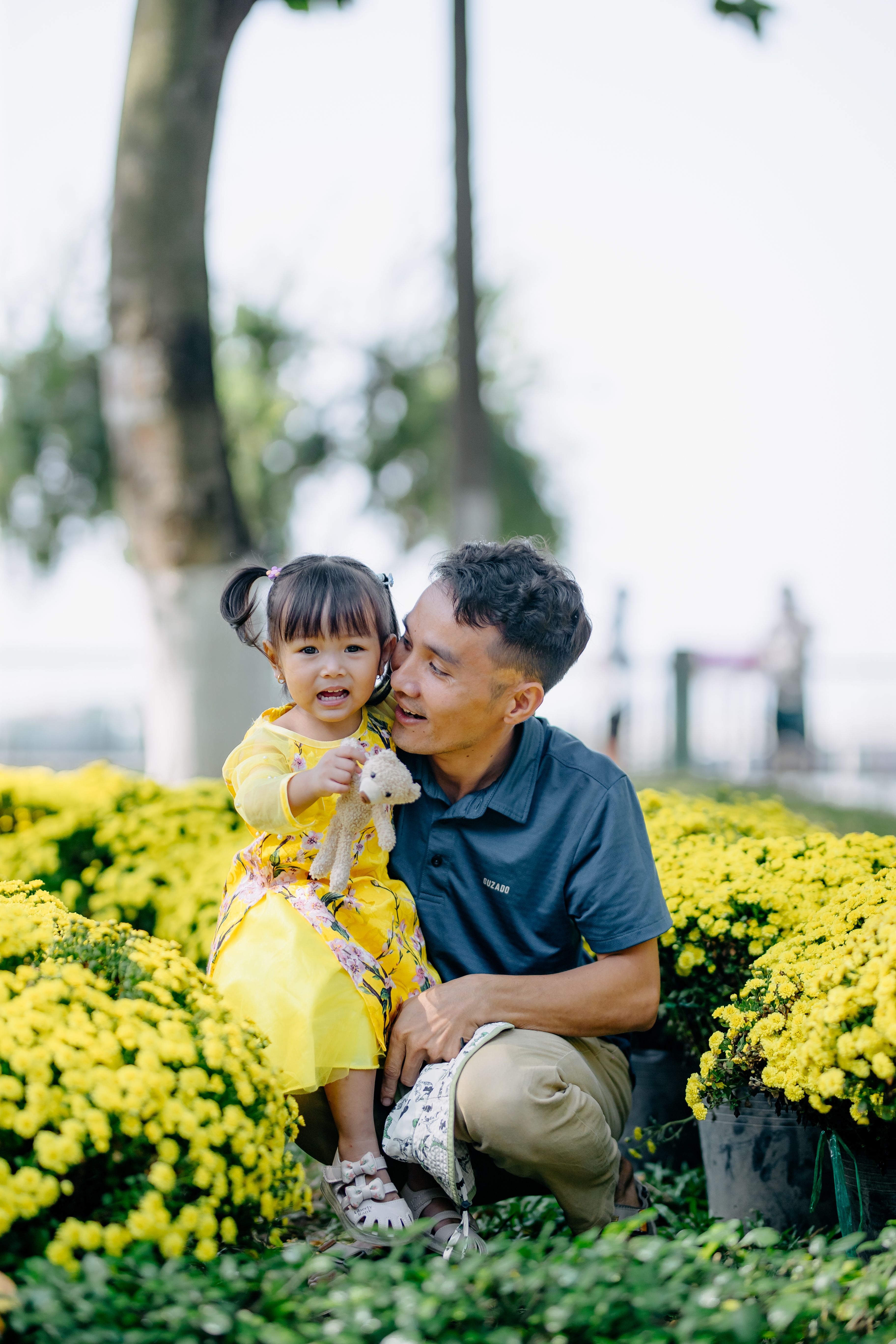 Father and Daughter in Yellow Dress Amidst Flowers · Free Stock Photo