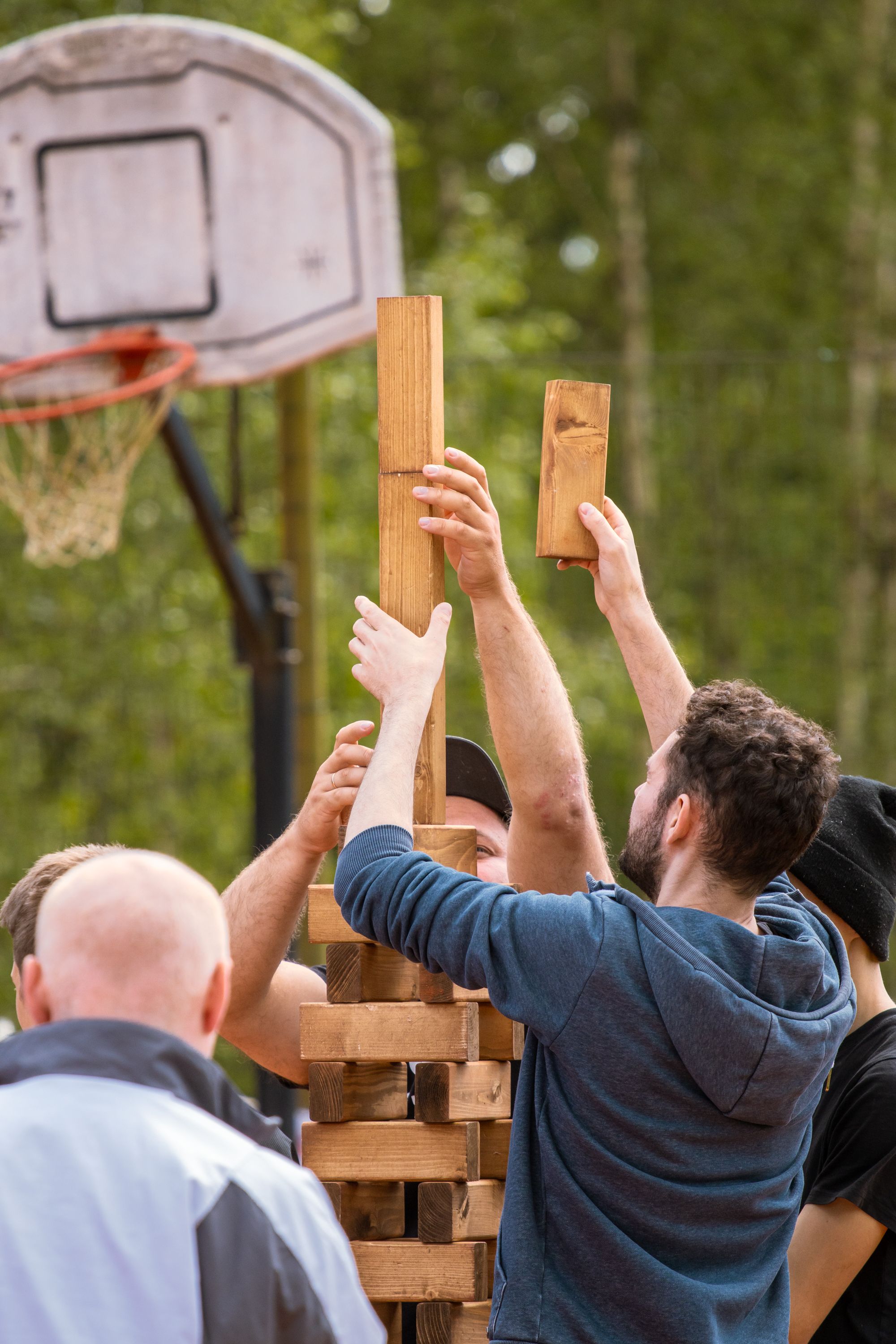 Team Building Activity with Wooden Blocks Outdoors · Free Stock Photo
