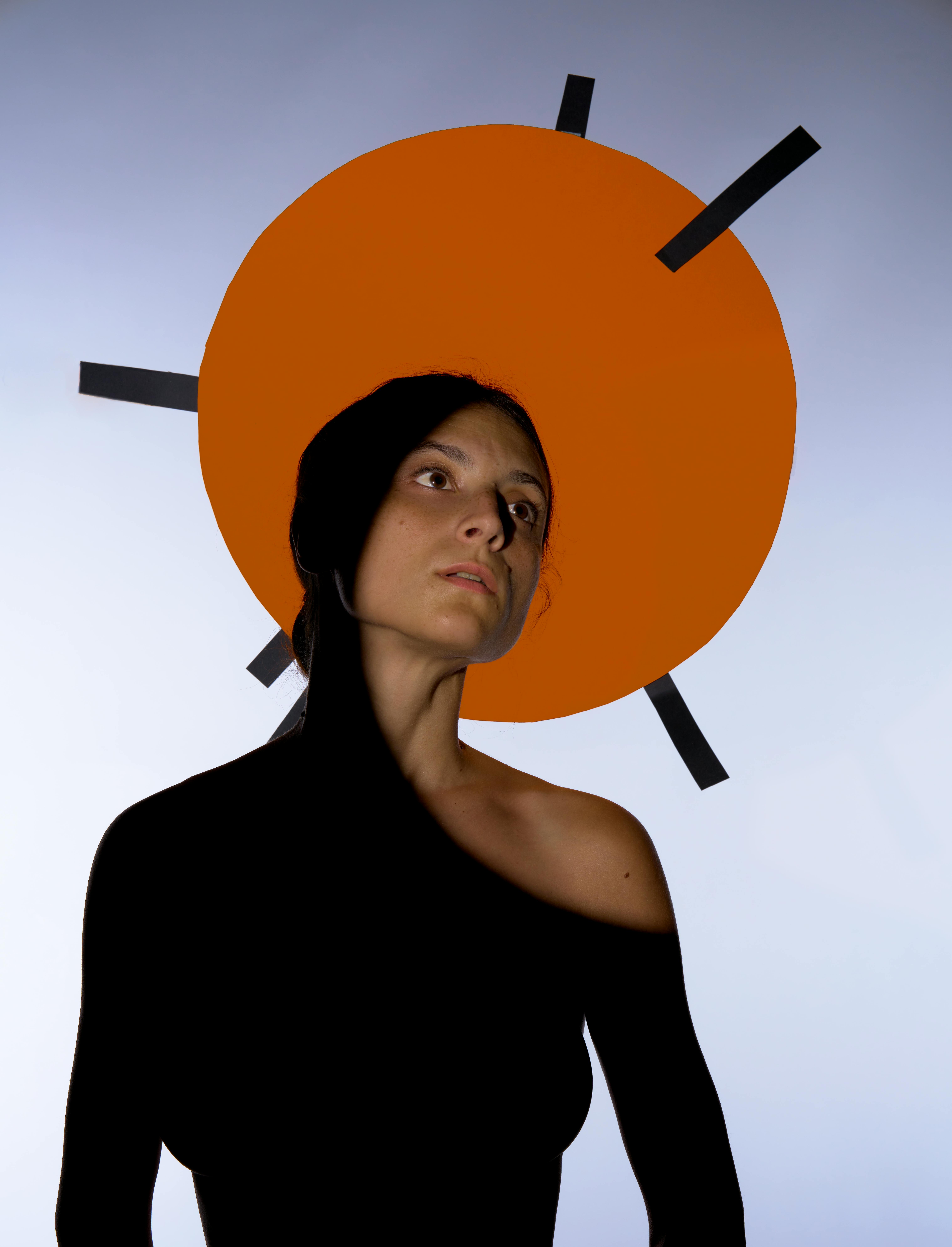Artistic Portrait with Minimalist Orange Halo · Free Stock Photo