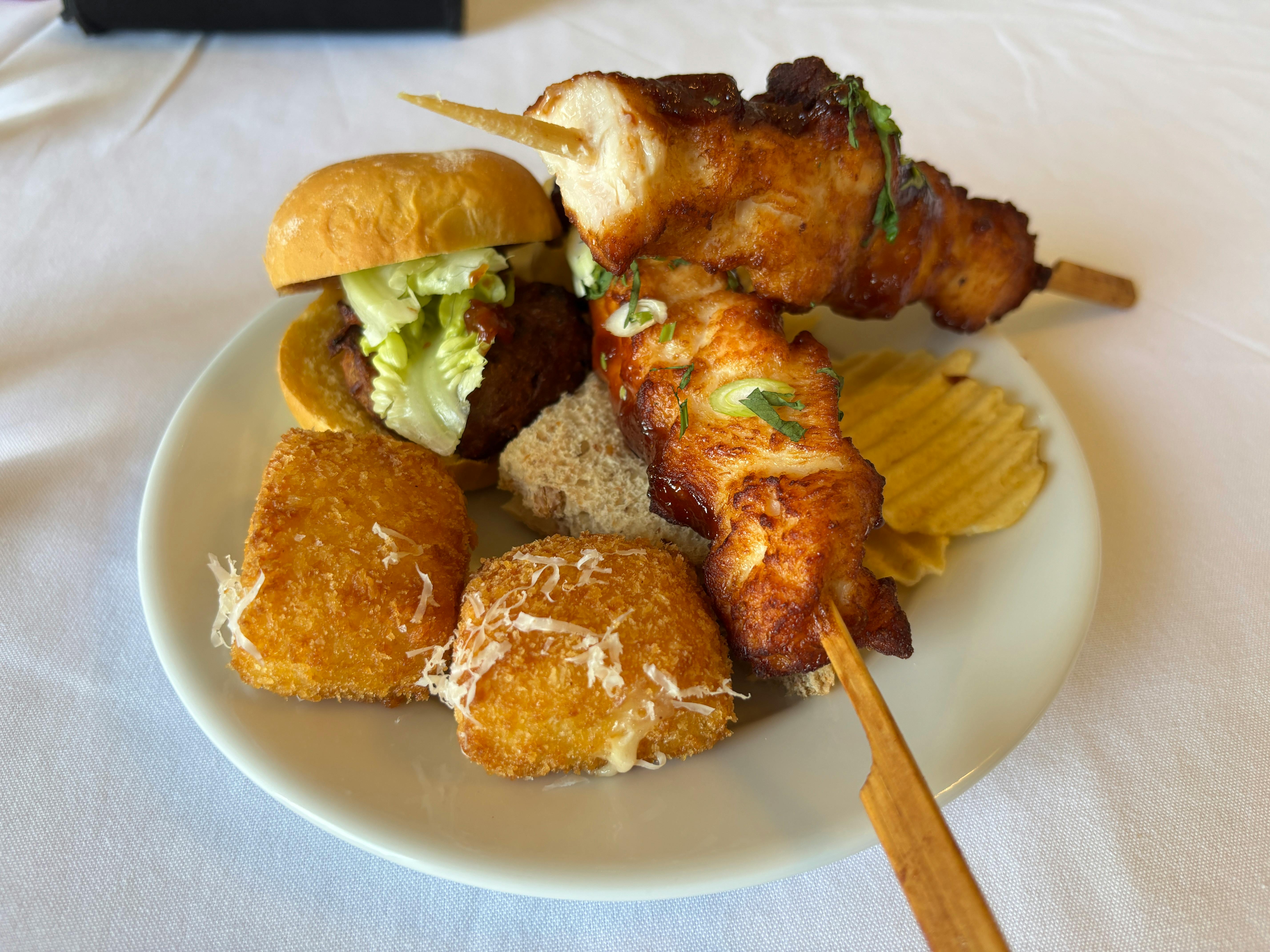 Plate of Diverse Appetizers on White Tablecloth · Free Stock Photo