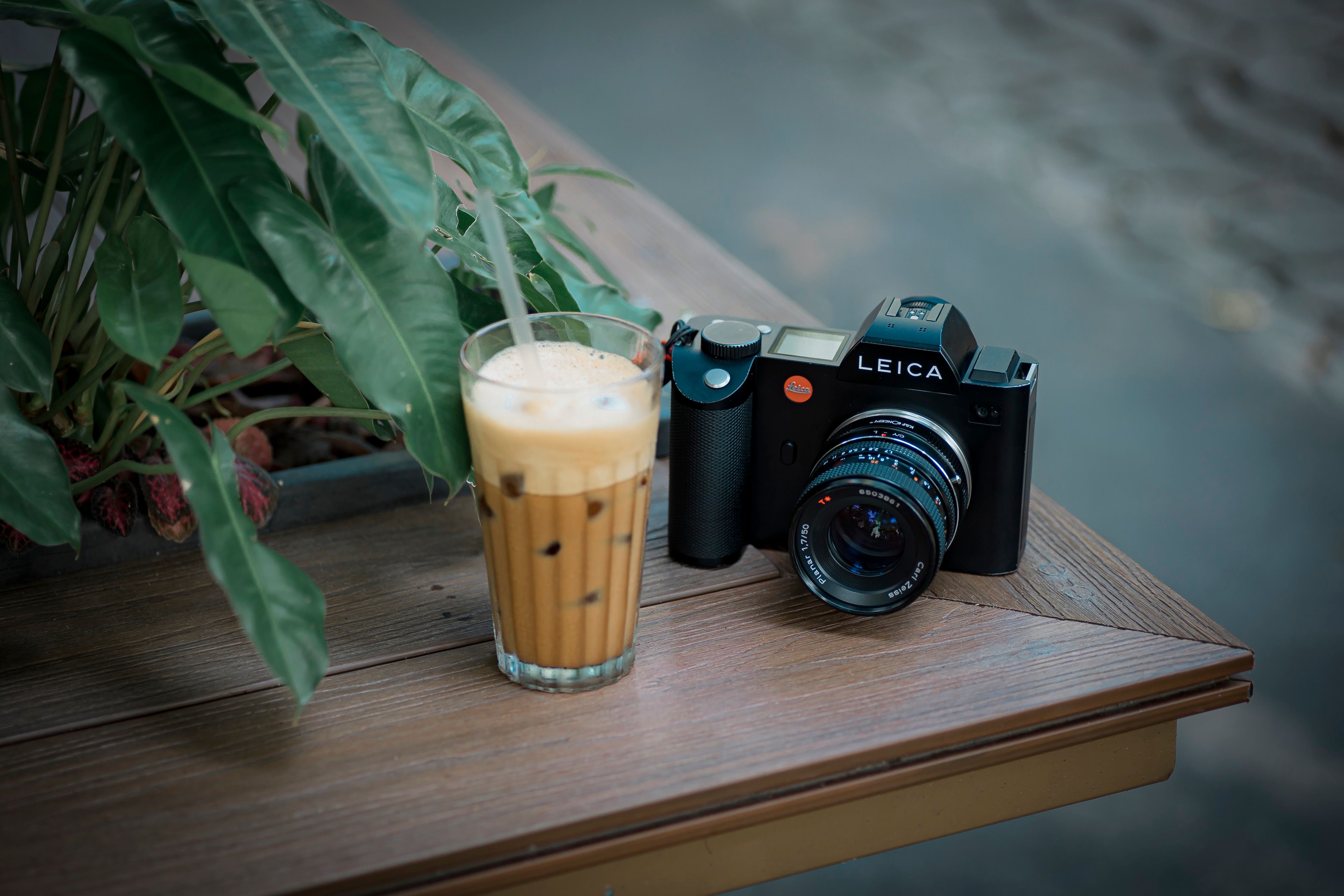 Modern Camera and Iced Coffee on Wooden Table · Free Stock Photo