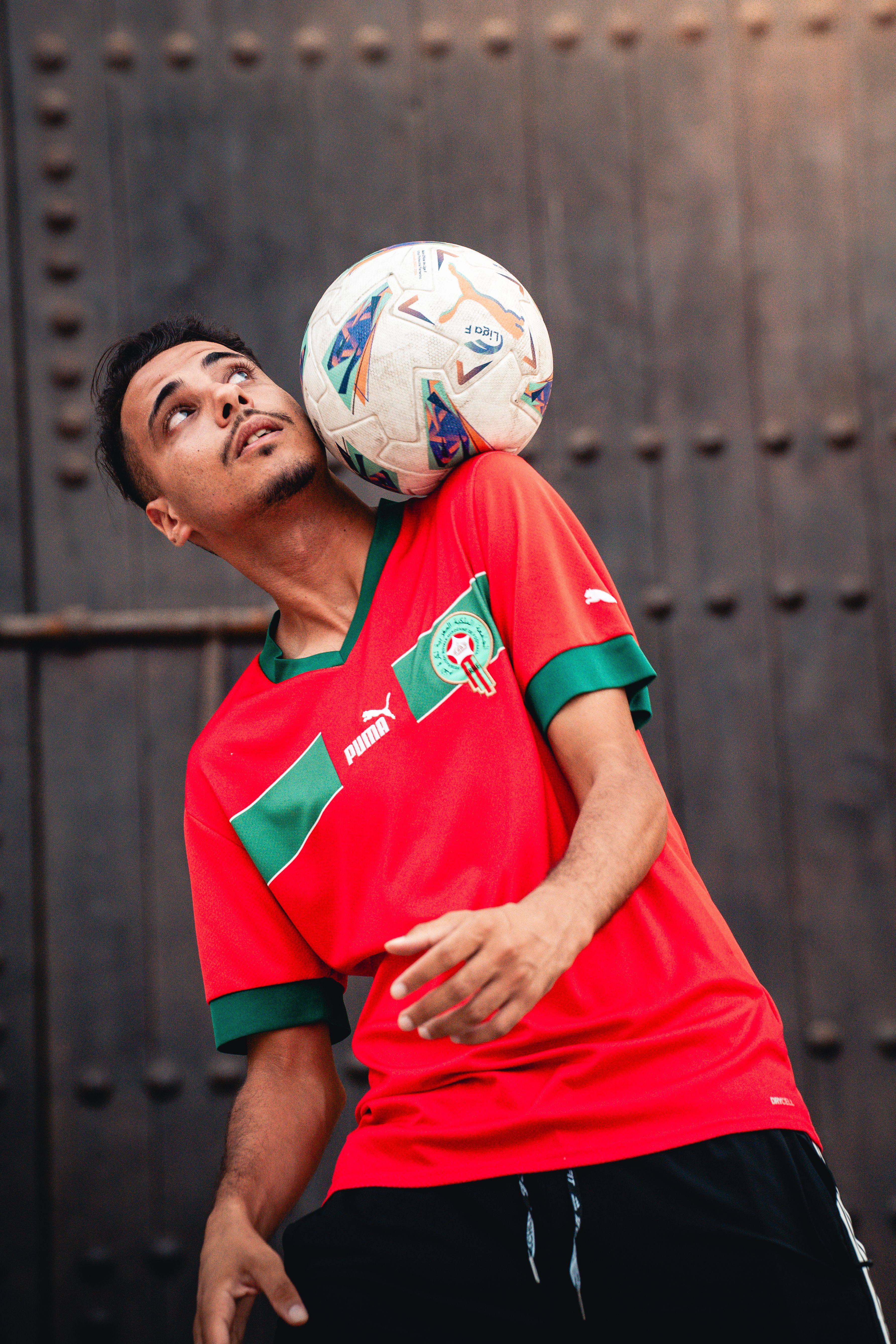 Soccer player balancing ball on head outdoors · Free Stock Photo