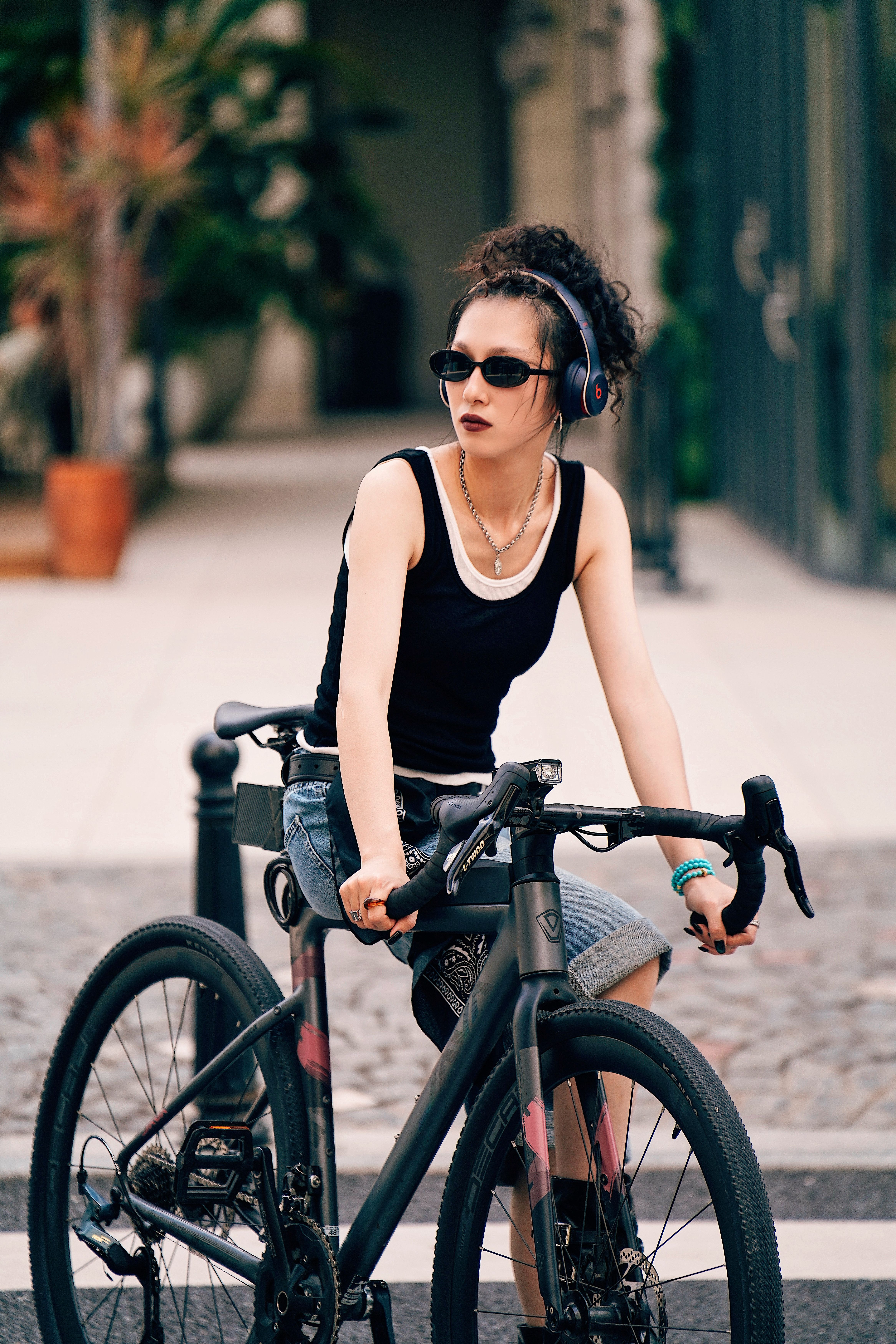Urban Biker Woman in Sunglasses on City Street · Free Stock Photo
