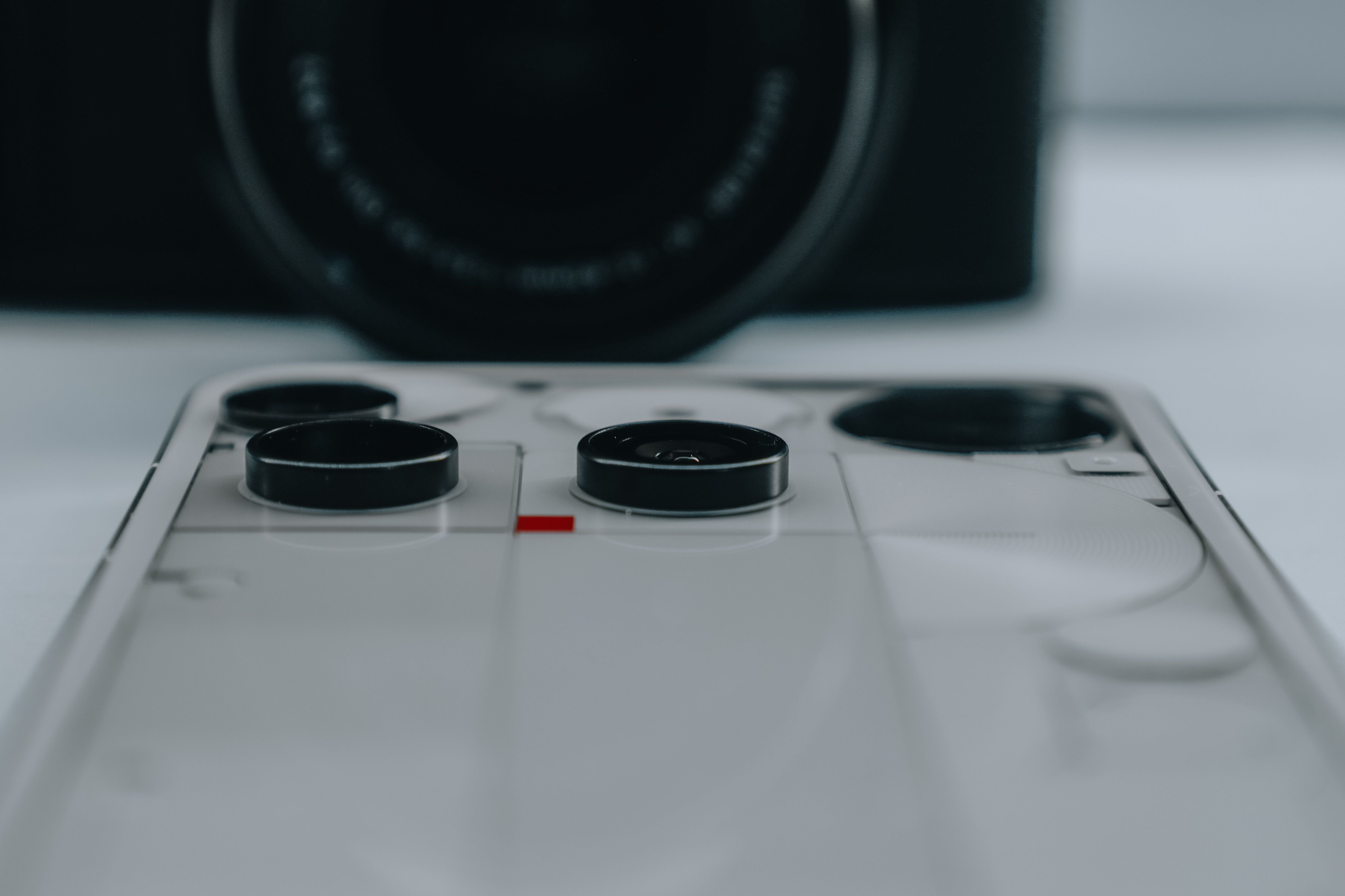 Close-up Modern Phone and Camera Lens · Free Stock Photo