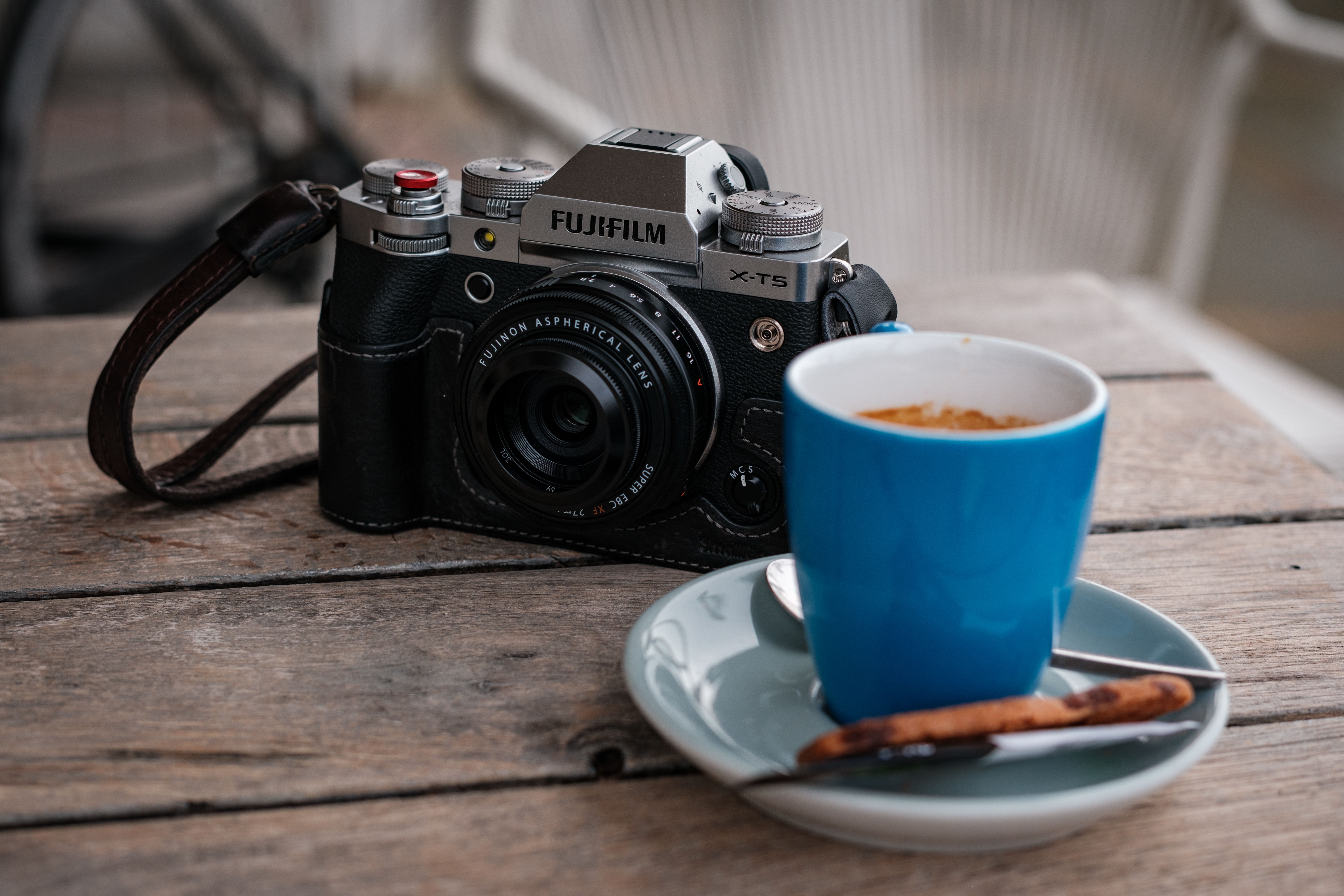 Camera with Coffee Cup on Rustic Table · Free Stock Photo
