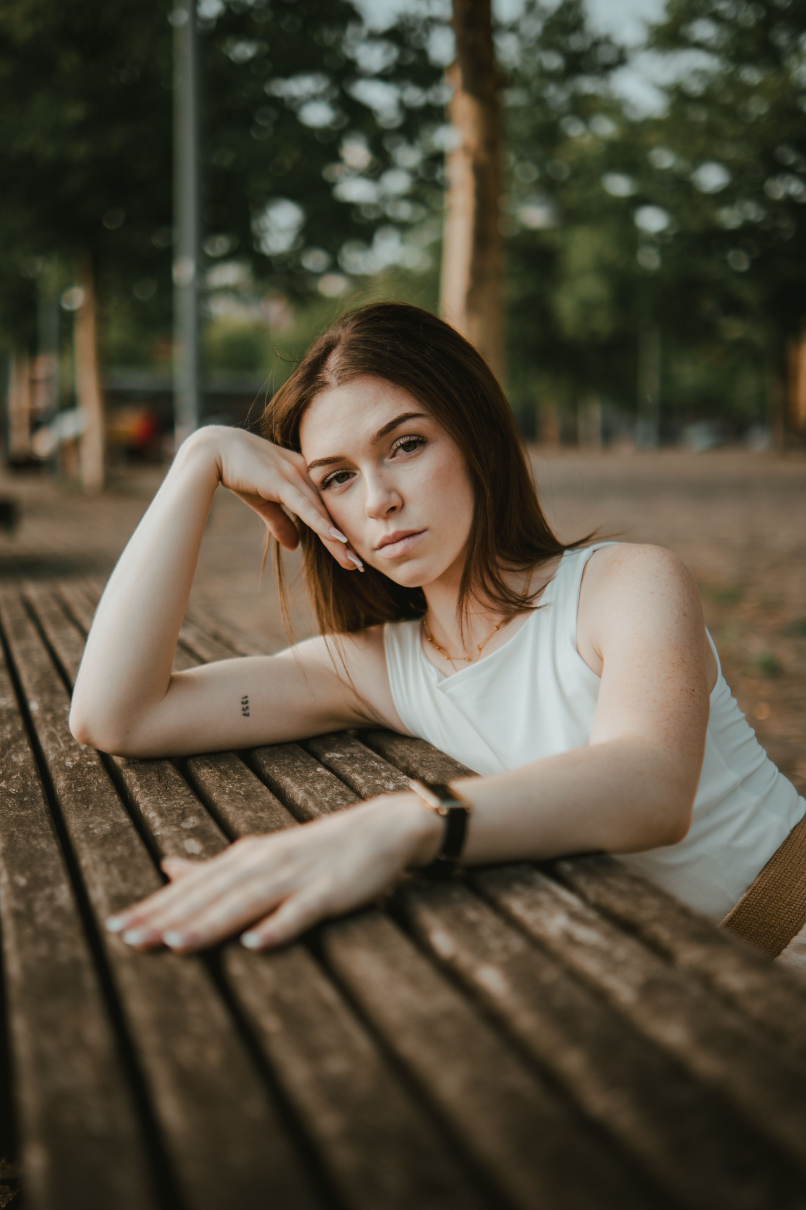Young Woman Relaxing on Outdoor Park Bench · Free Stock Photo