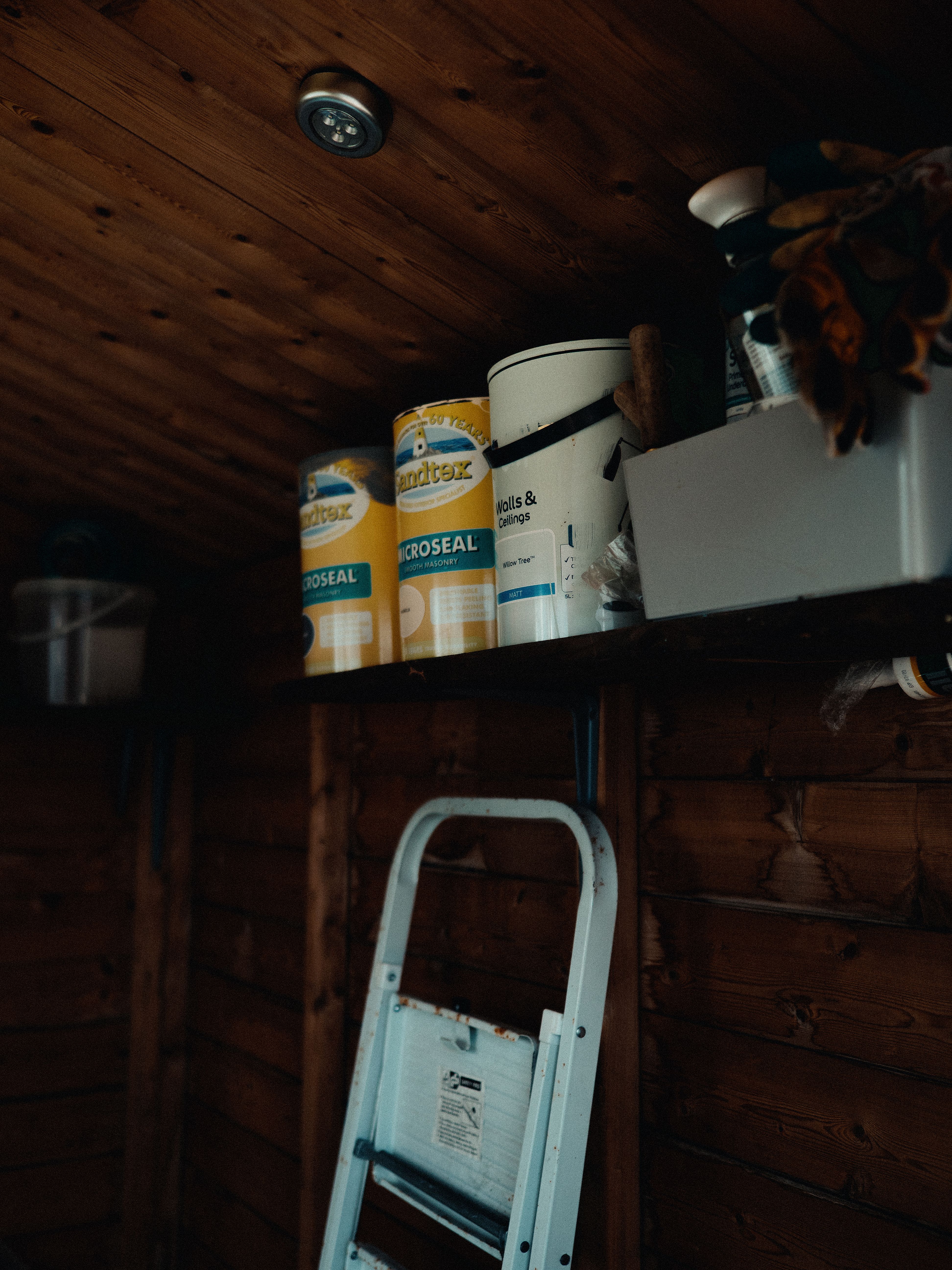 Interior of a Wooden Shed with Ladders and Paint · Free Stock Photo