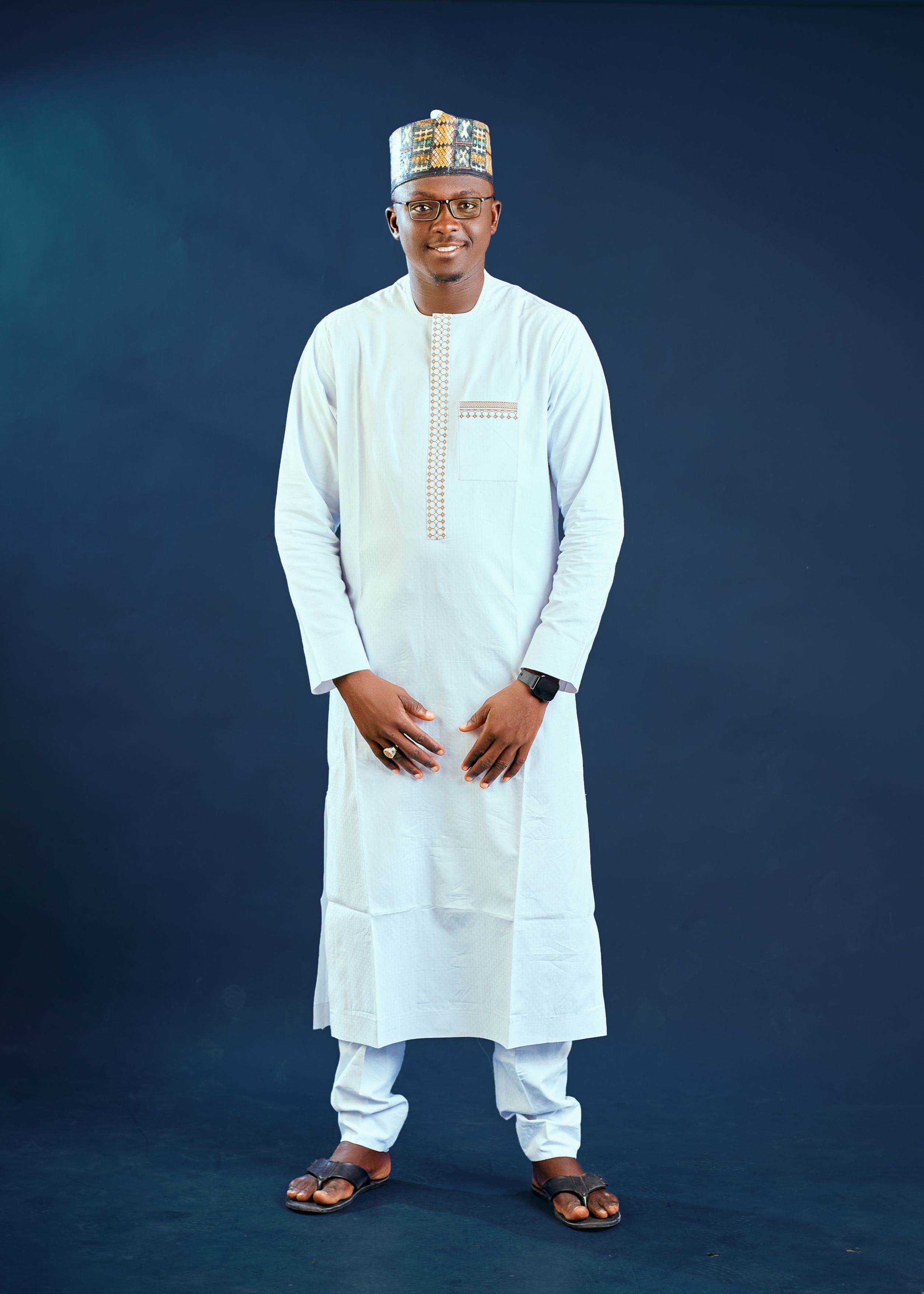 Man in Traditional White Attire Posing Studio Portrait · Free Stock Photo