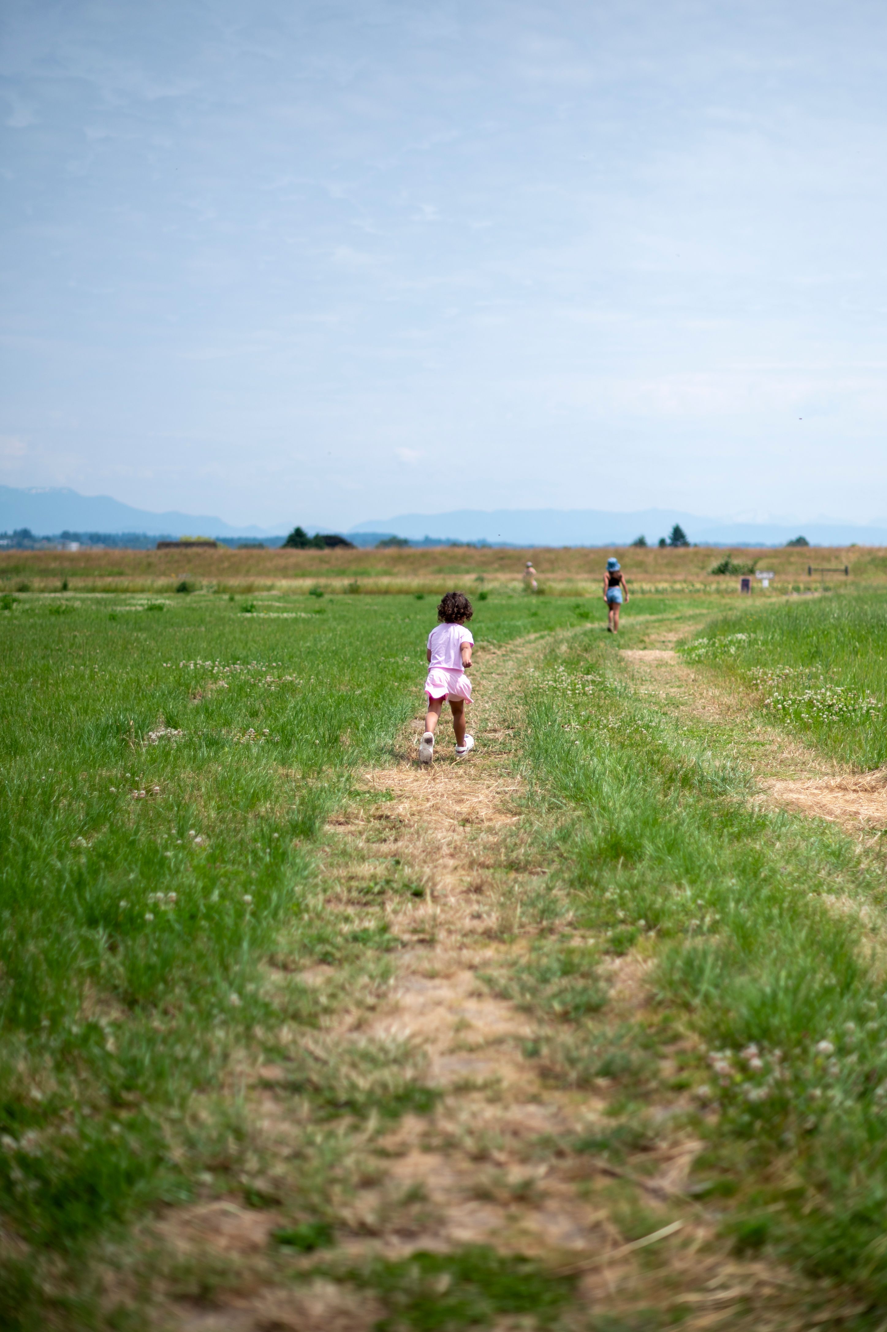Child Running Through Open Field on Sunny Day · Free Stock Photo