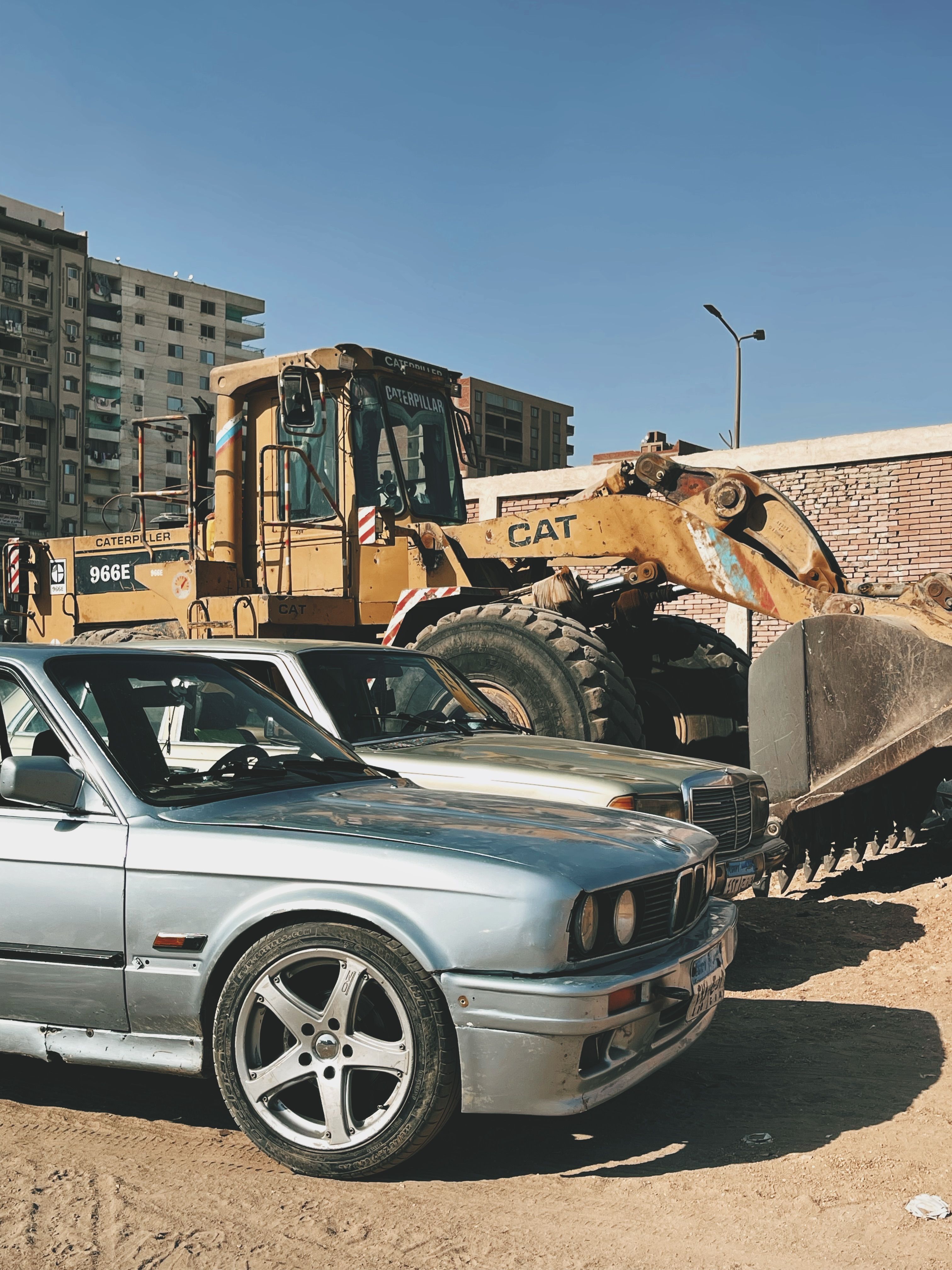 Urban Construction Site with Cars and Bulldozer · Free Stock Photo