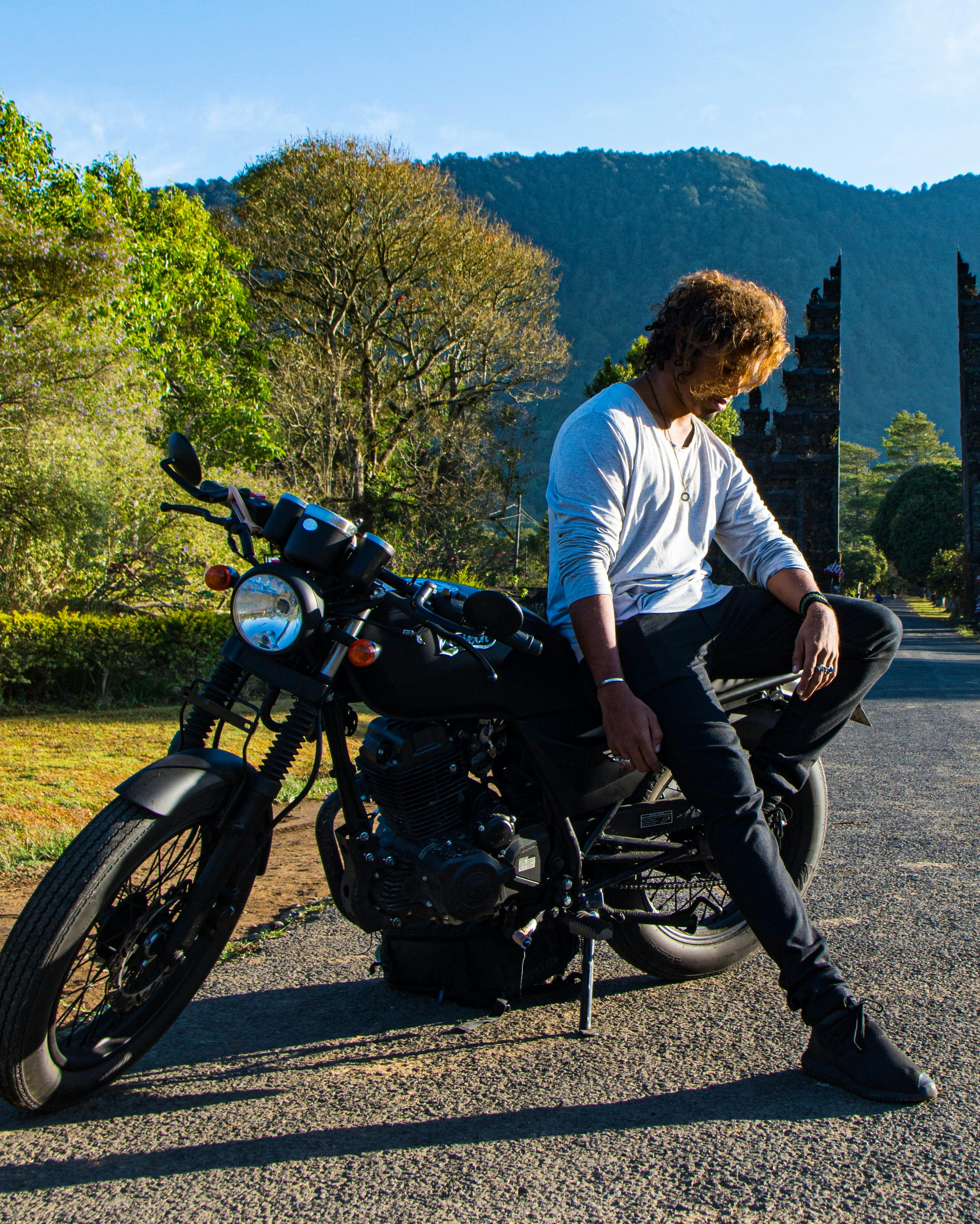 A Person Standing Beside a Motorcycle Carrying Loads of Flowers · Free ...