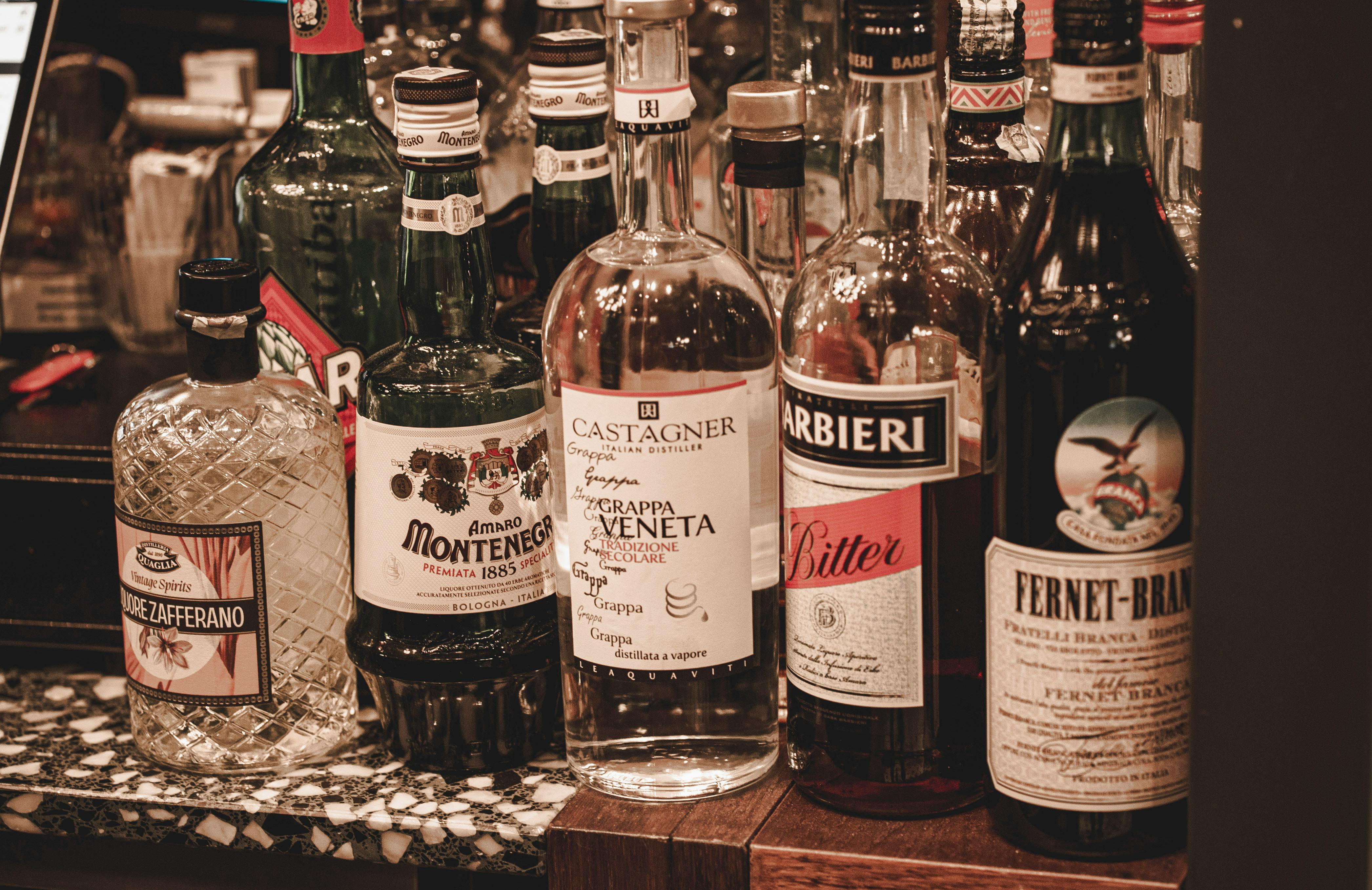 Assorted Liquor Bottles on Bar Counter in Milan · Free Stock Photo