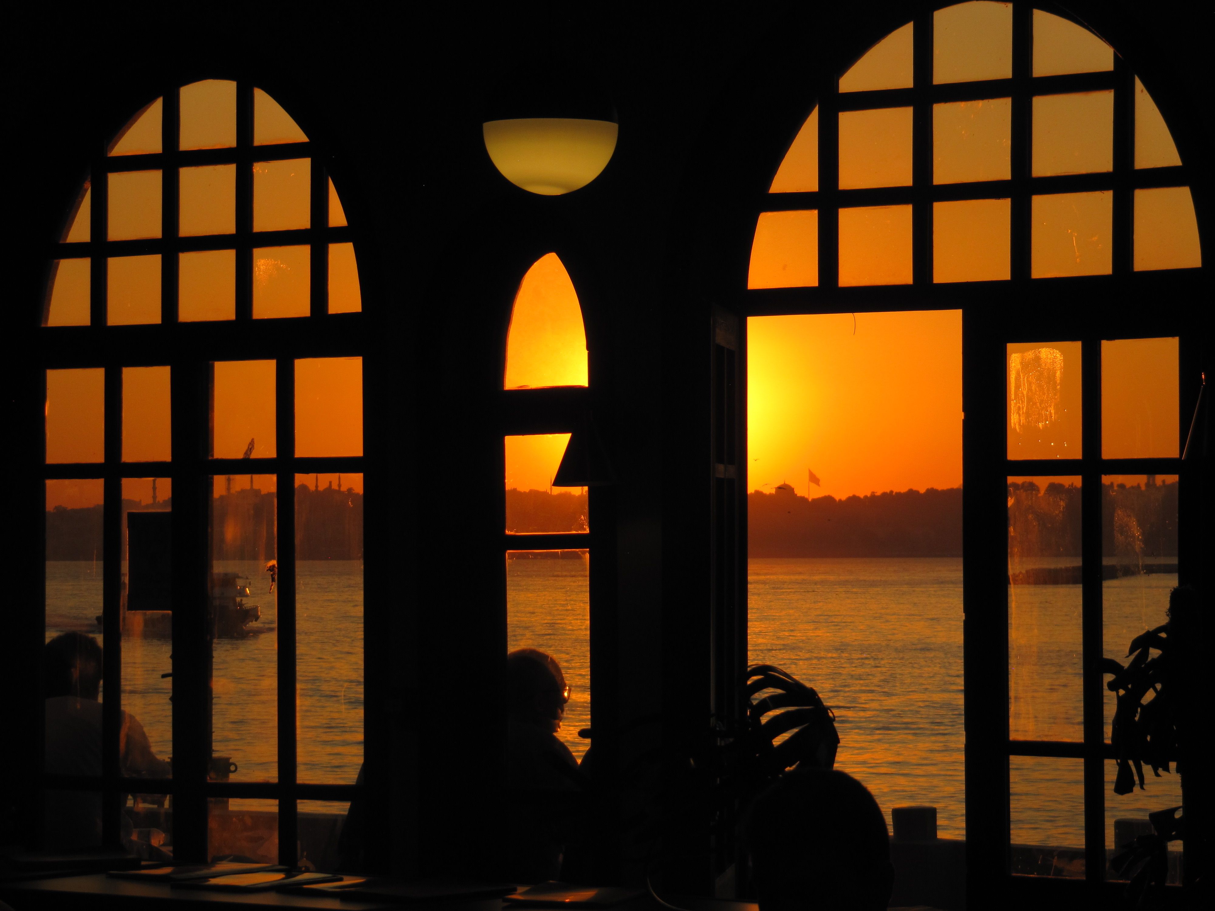 Serene Sunset View Through Arched Windows · Free Stock Photo