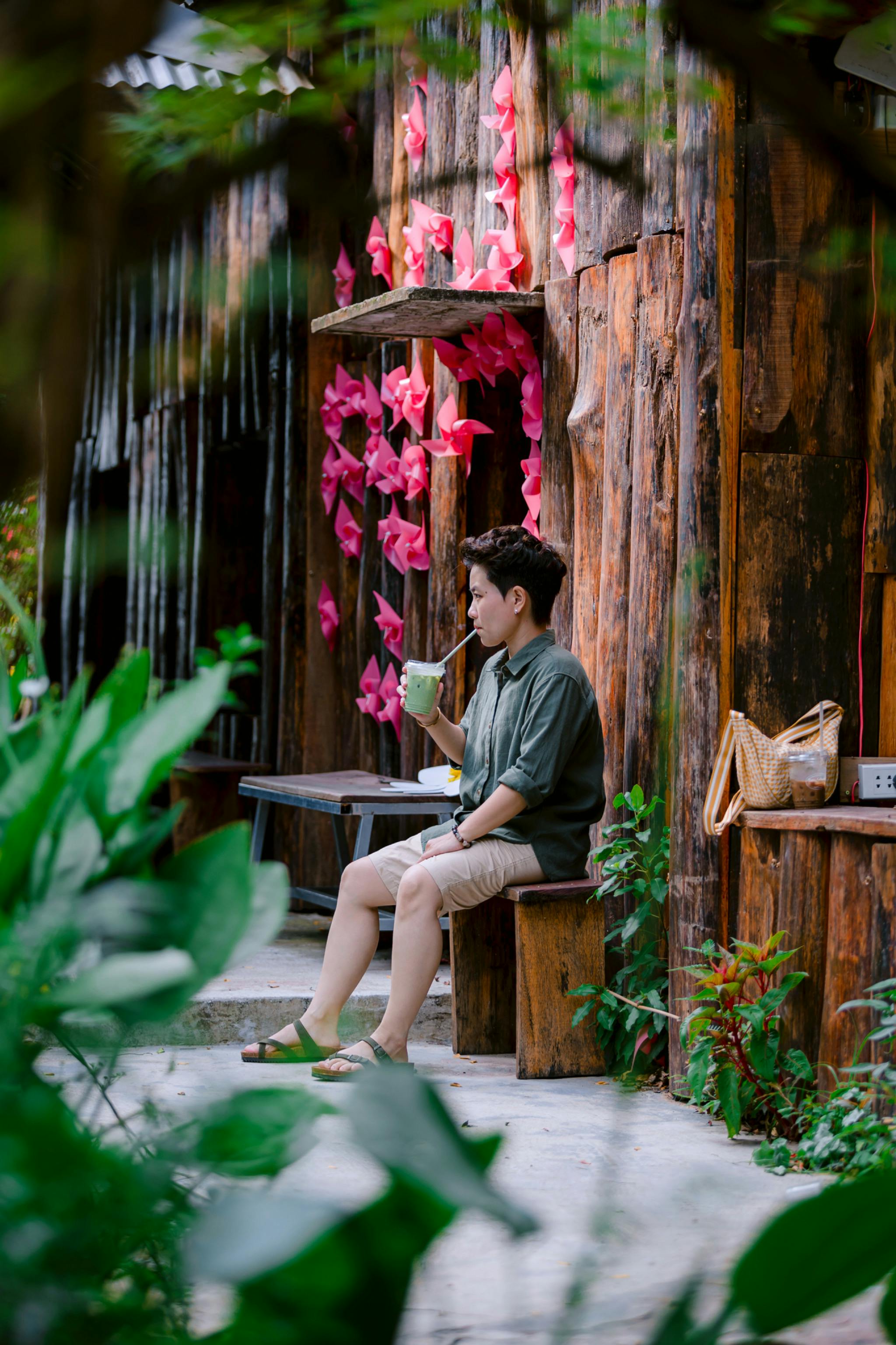 Relaxed Individual Enjoying Coffee Outdoors · Free Stock Photo