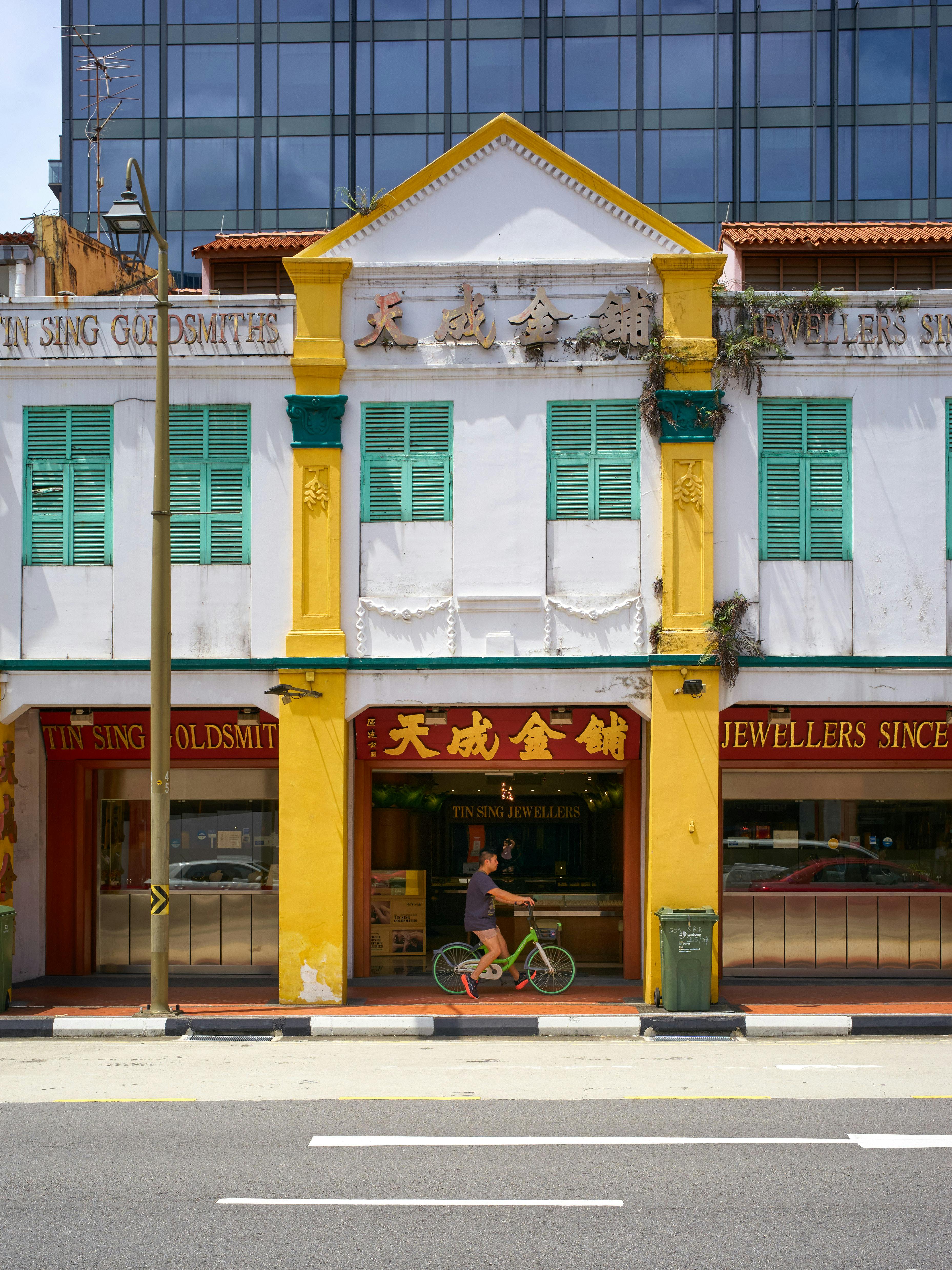 Colorful Chinatown Building with Cyclist · Free Stock Photo