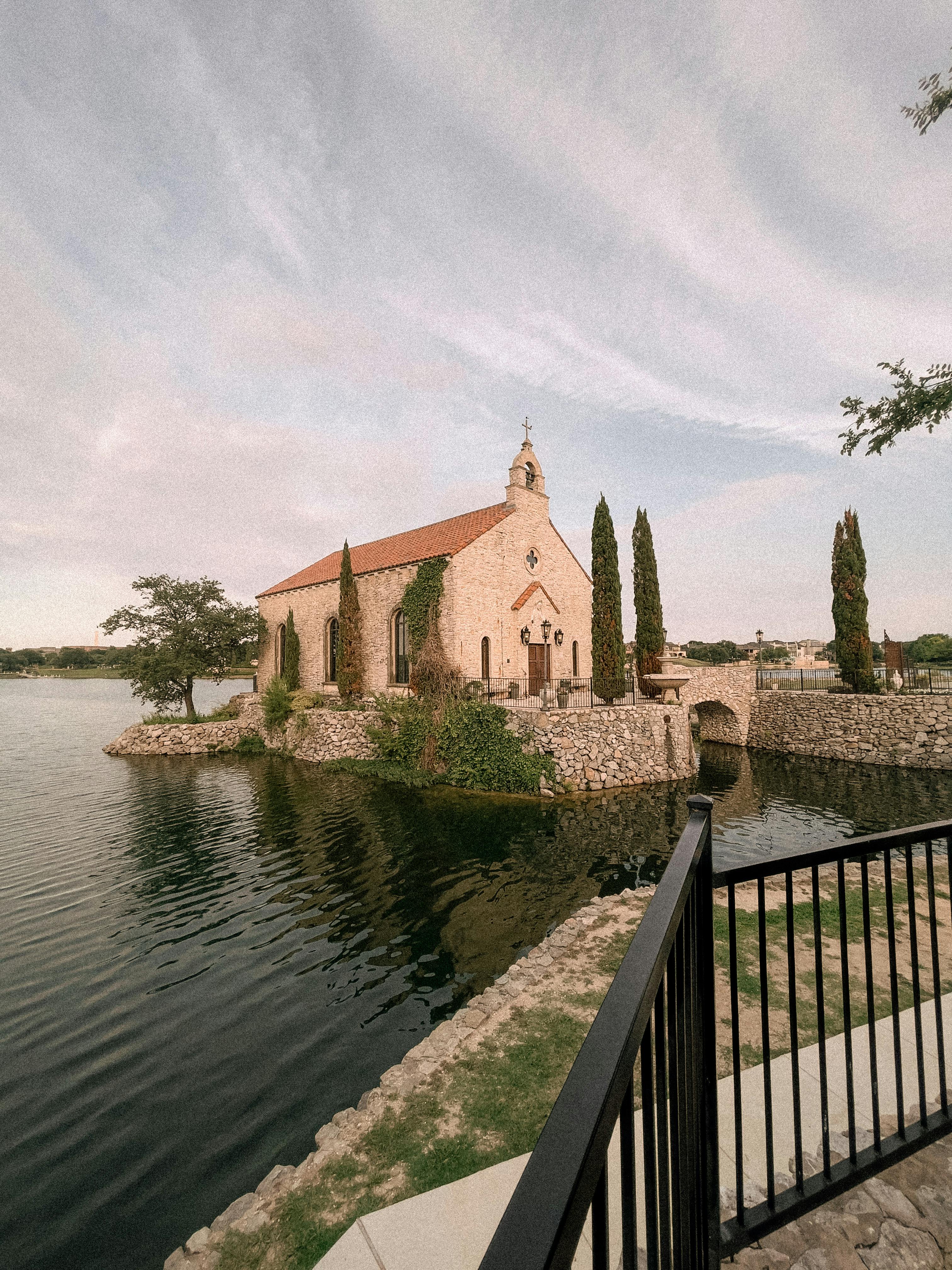 Idyllic Stone Chapel on Serene Lake at Sunset · Free Stock Photo
