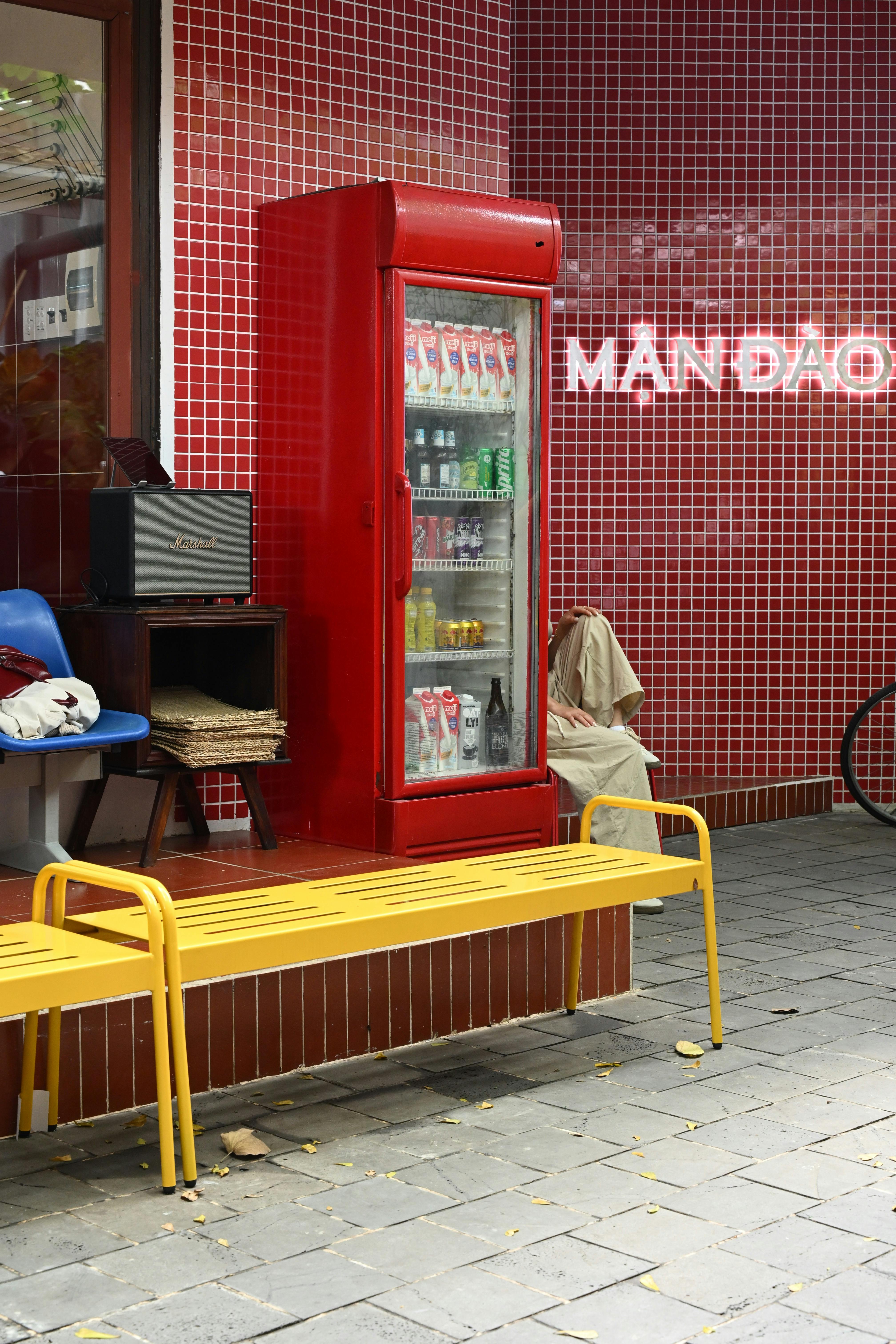 Red Vending Machine Outside Shop With Yellow Bench · Free Stock Photo
