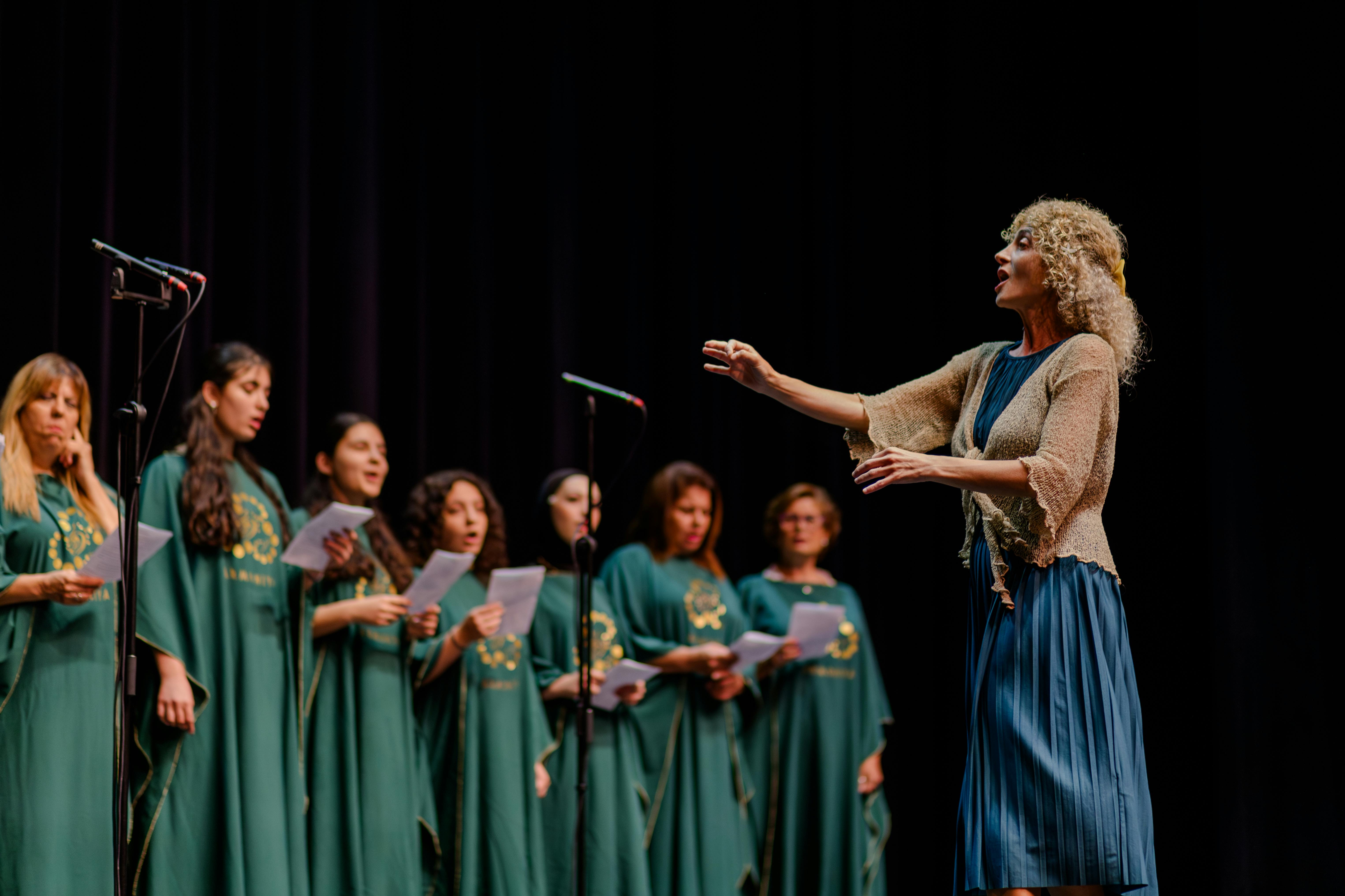 Choral Performance with Conductor Leading Singers · Free Stock Photo