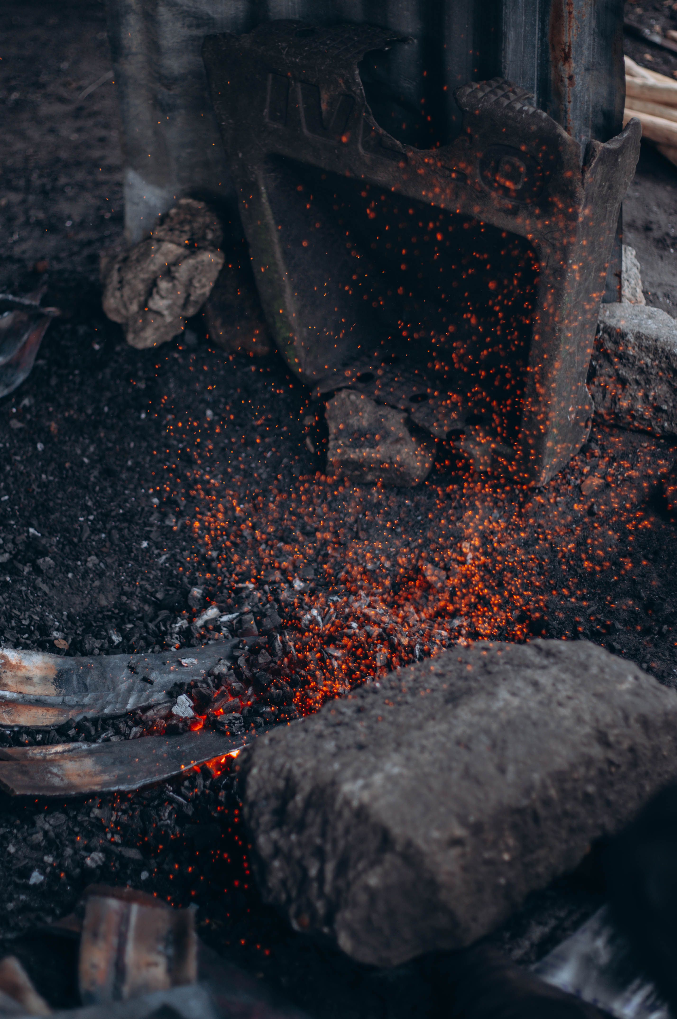 Glowing Embers and Ashes in a Dark Hearth · Free Stock Photo