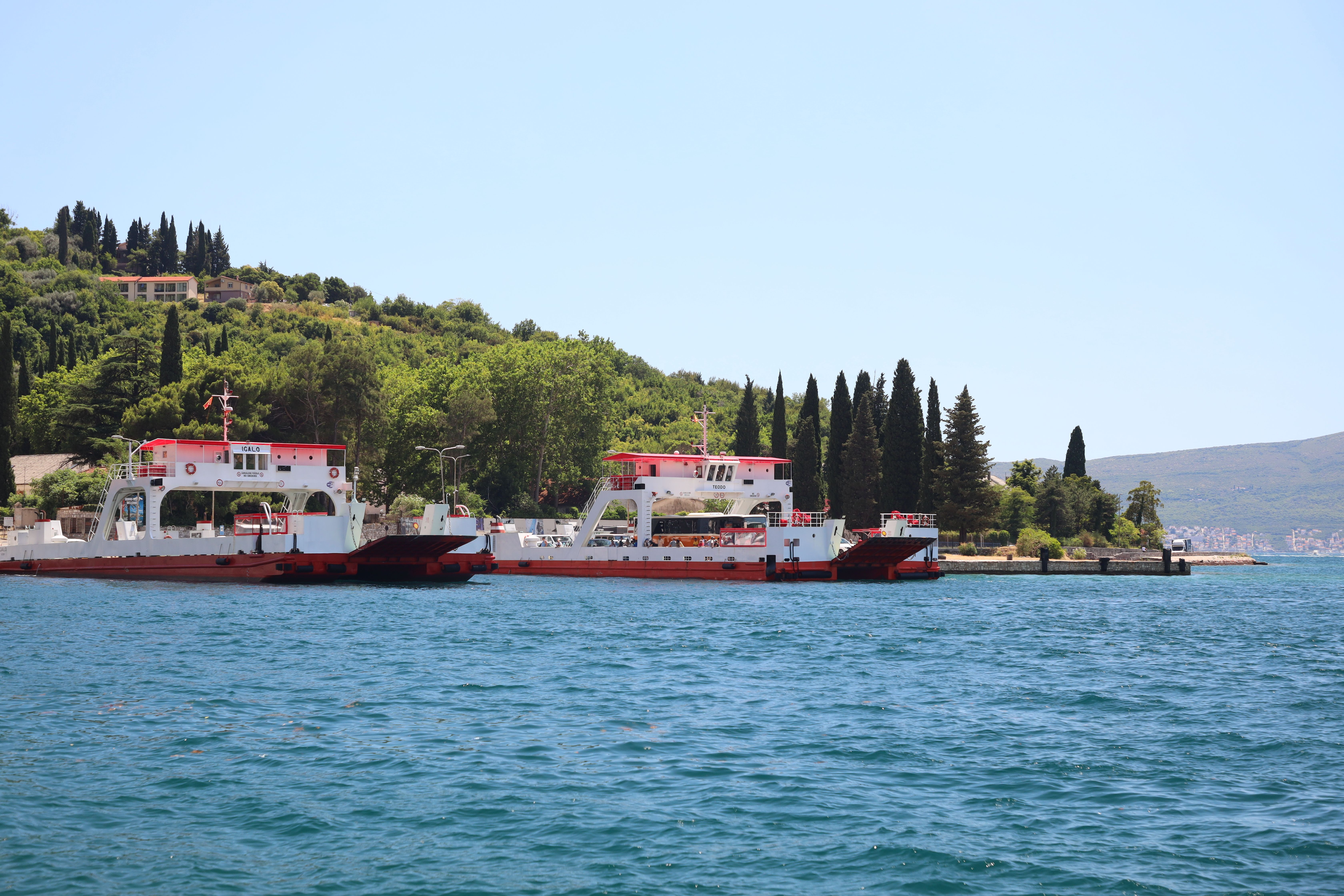 Ferries Docked at Scenic Waterfront with Hills · Free Stock Photo