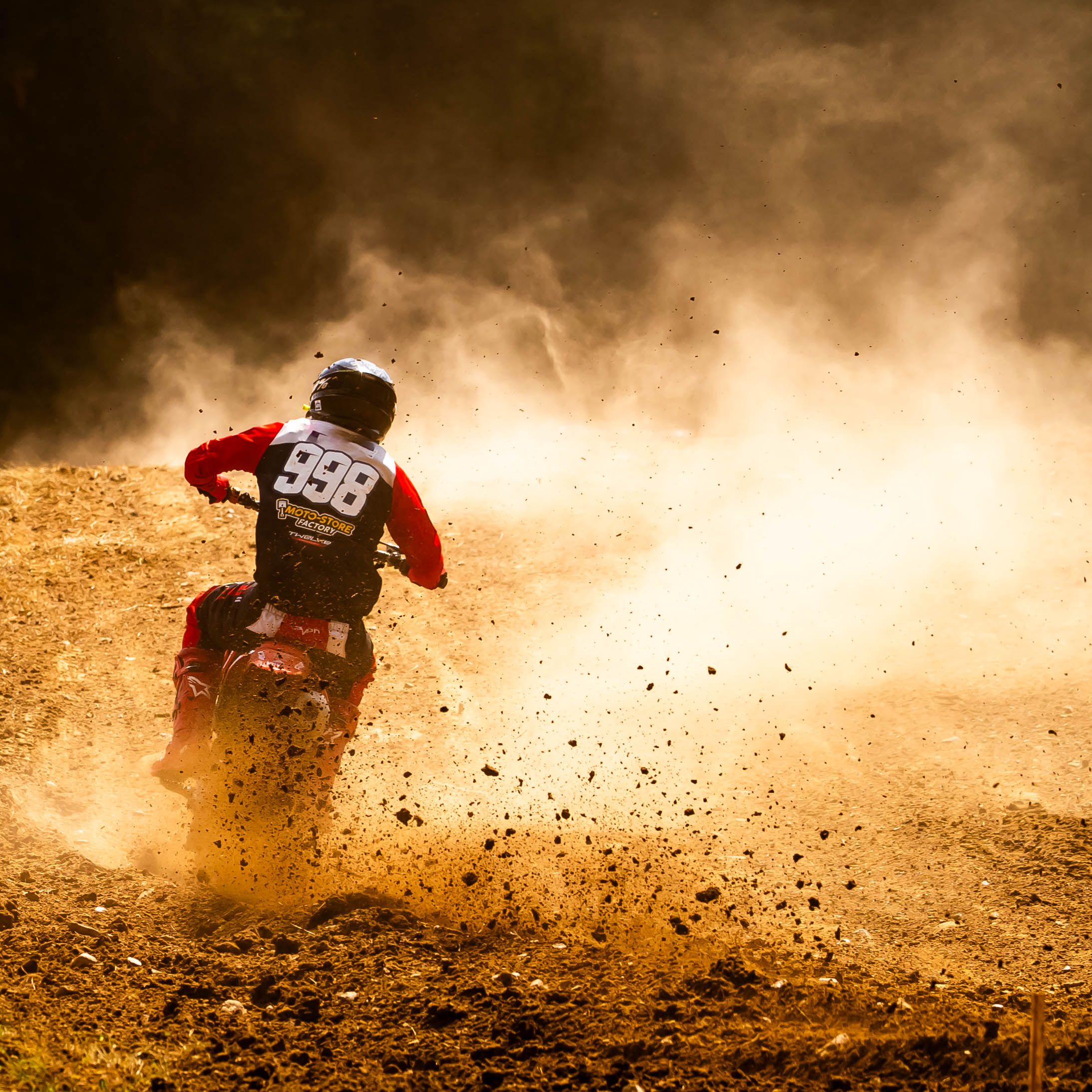 Dirt Biker Racing Through Dust at Sunset · Free Stock Photo