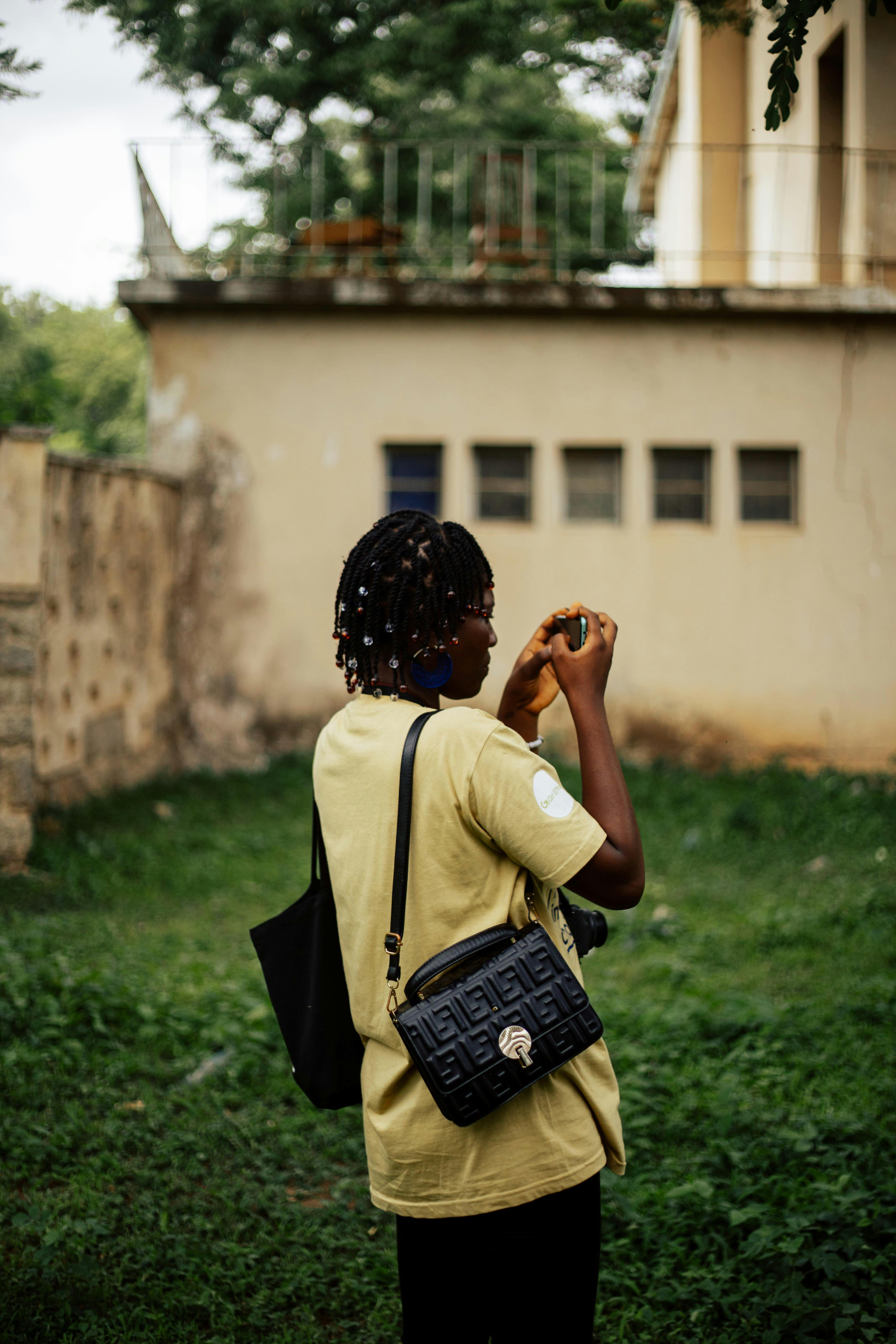 Young Woman Exploring Urban Green Space Outdoors · Free Stock Photo
