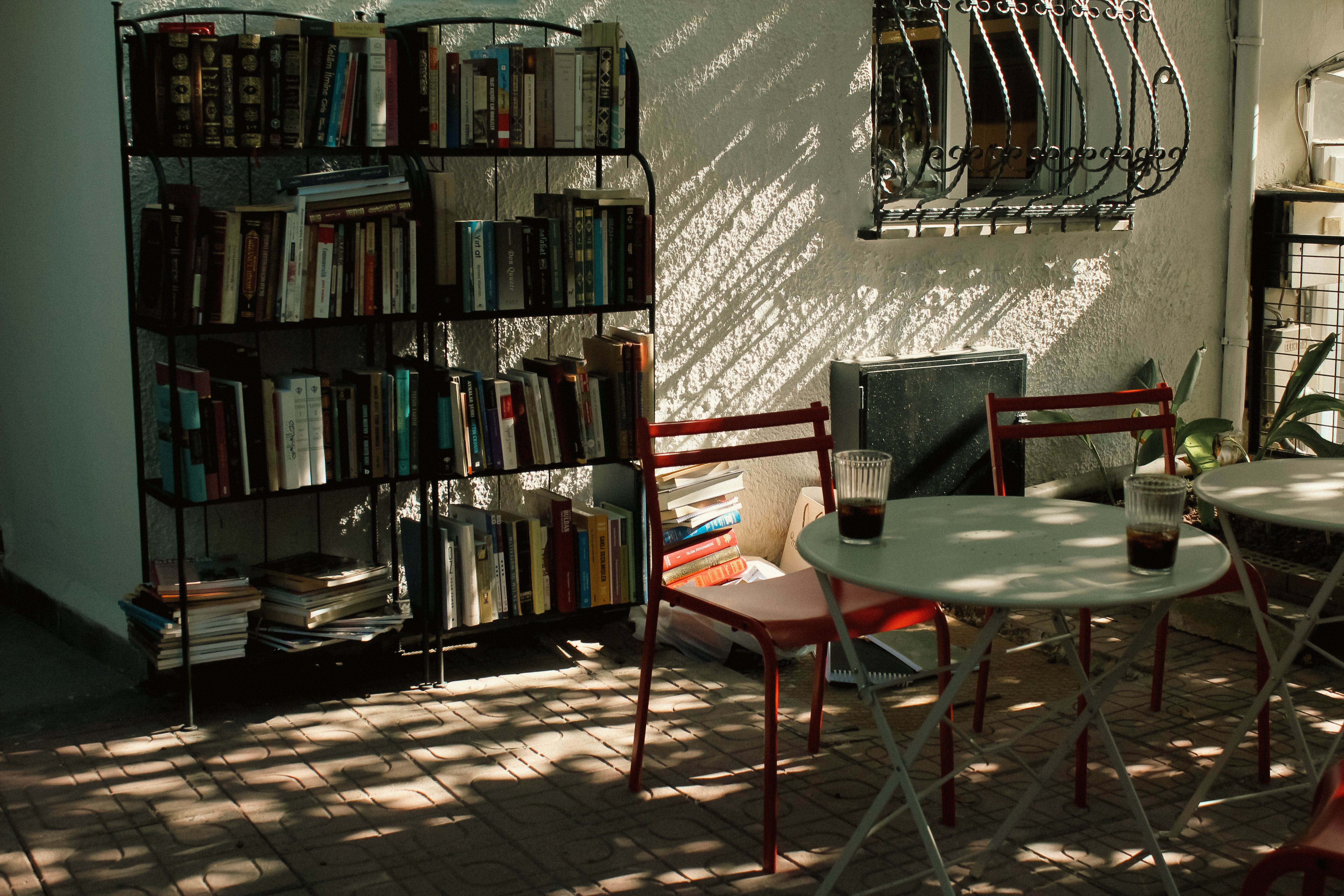 Cozy Outdoor Reading Space with Books and Chairs · Free Stock Photo