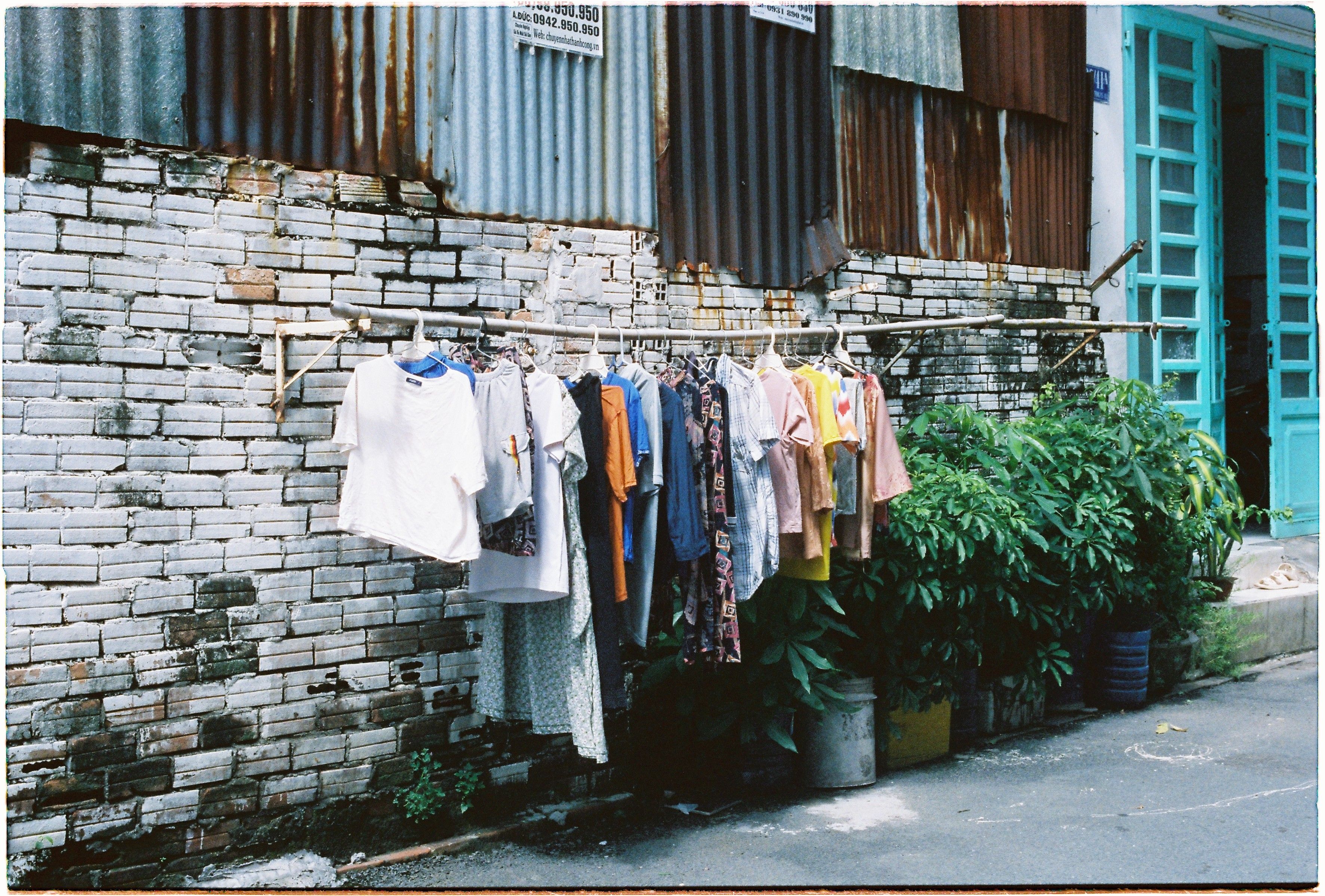 Outdoor Clothes Rack Against Rustic Brick Wall · Free Stock Photo
