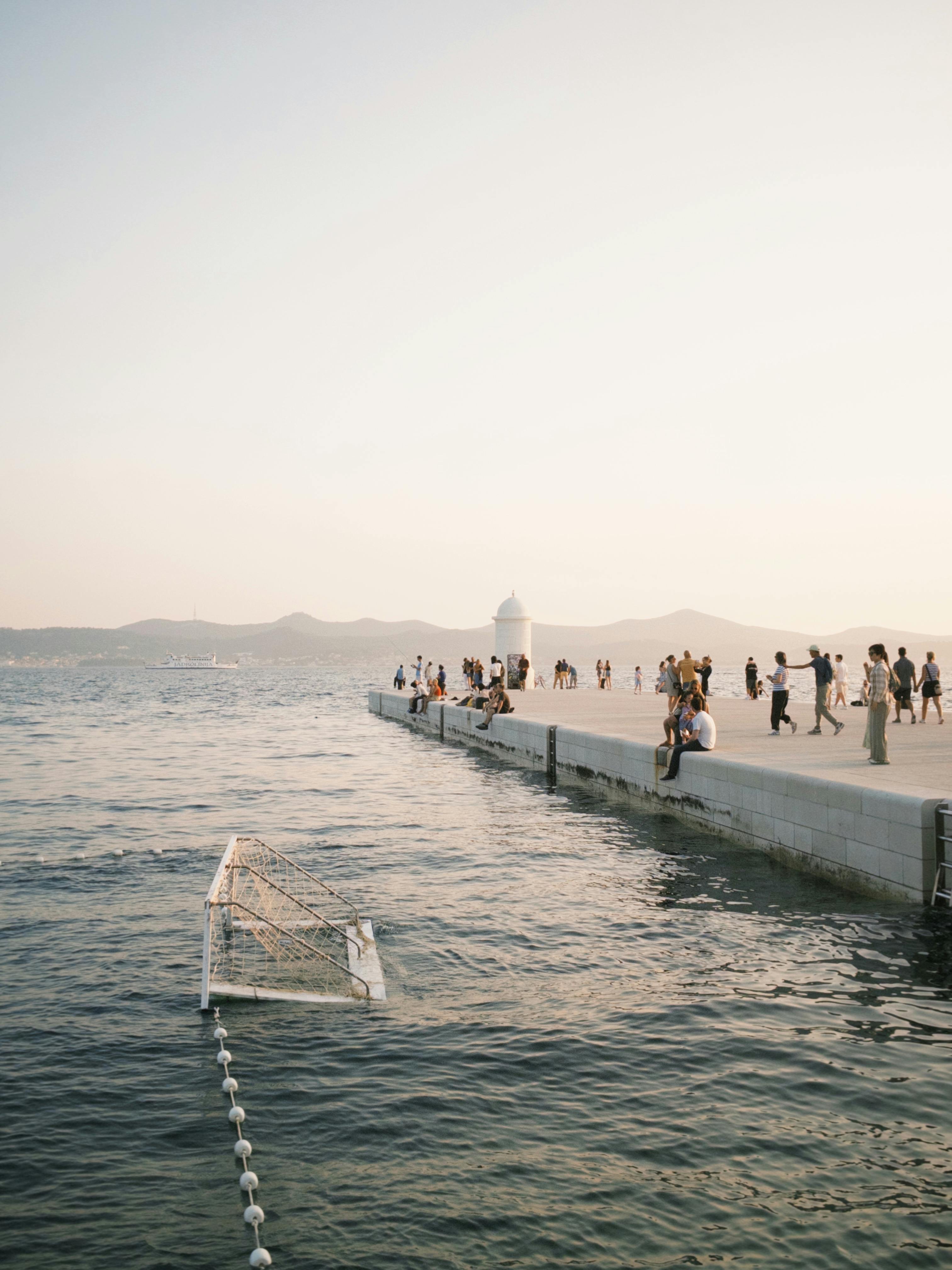 Crowd Enjoying Scenic Sunset at Zadar Waterfront · Free Stock Photo