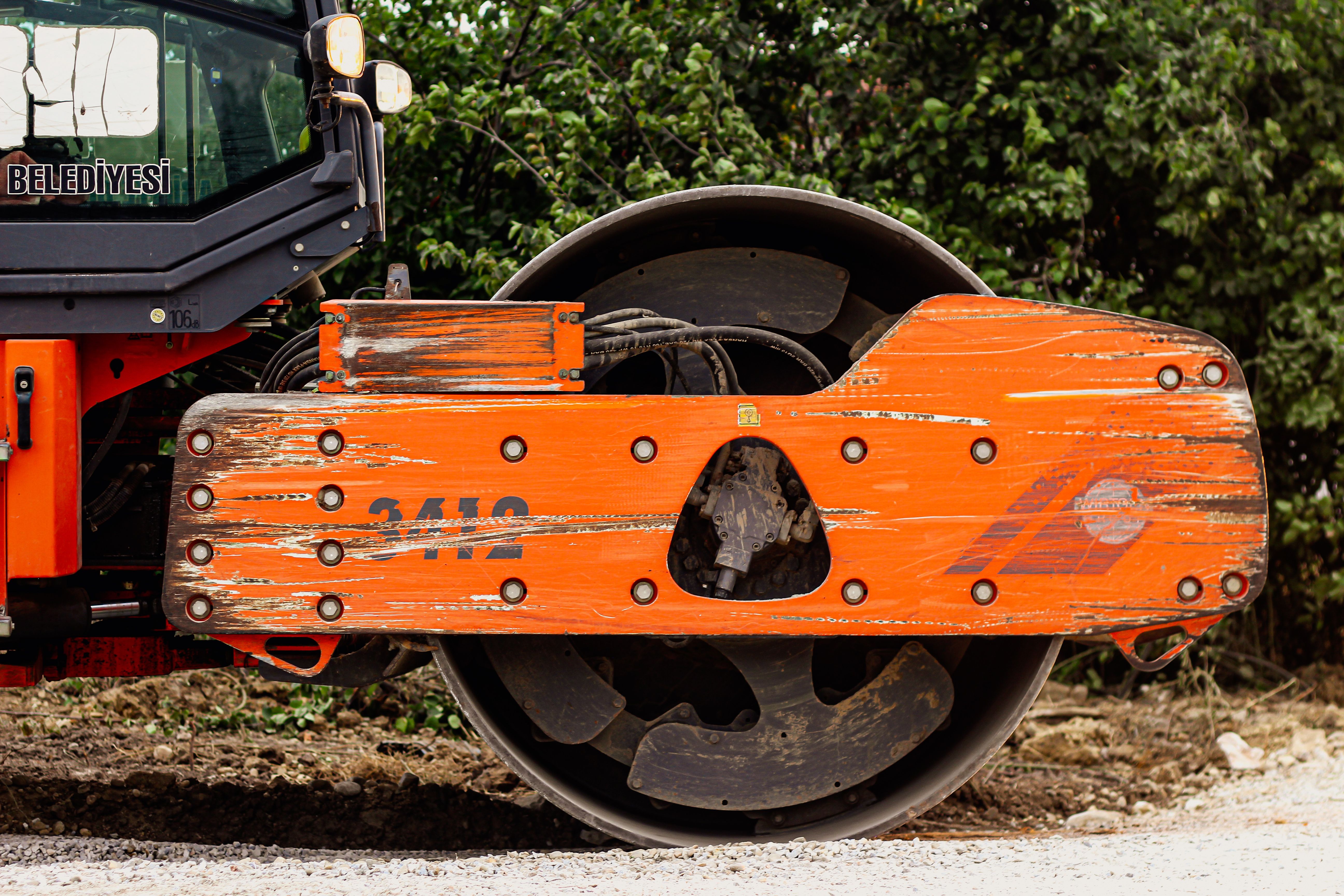 Vibrant Orange Steamroller on Construction Site · Free Stock Photo