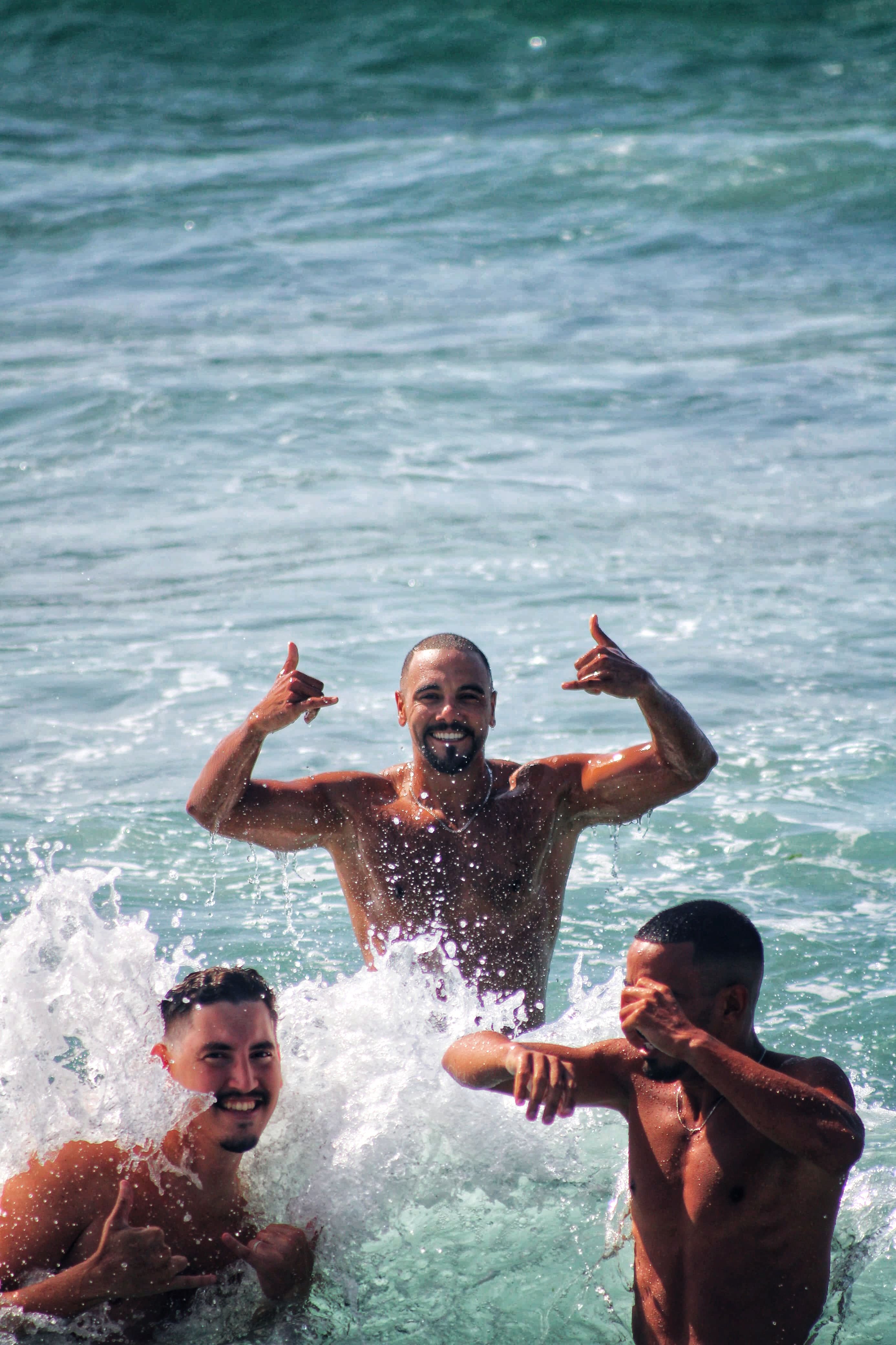 Three Friends Enjoying a Fun Swim in the Ocean · Free Stock Photo