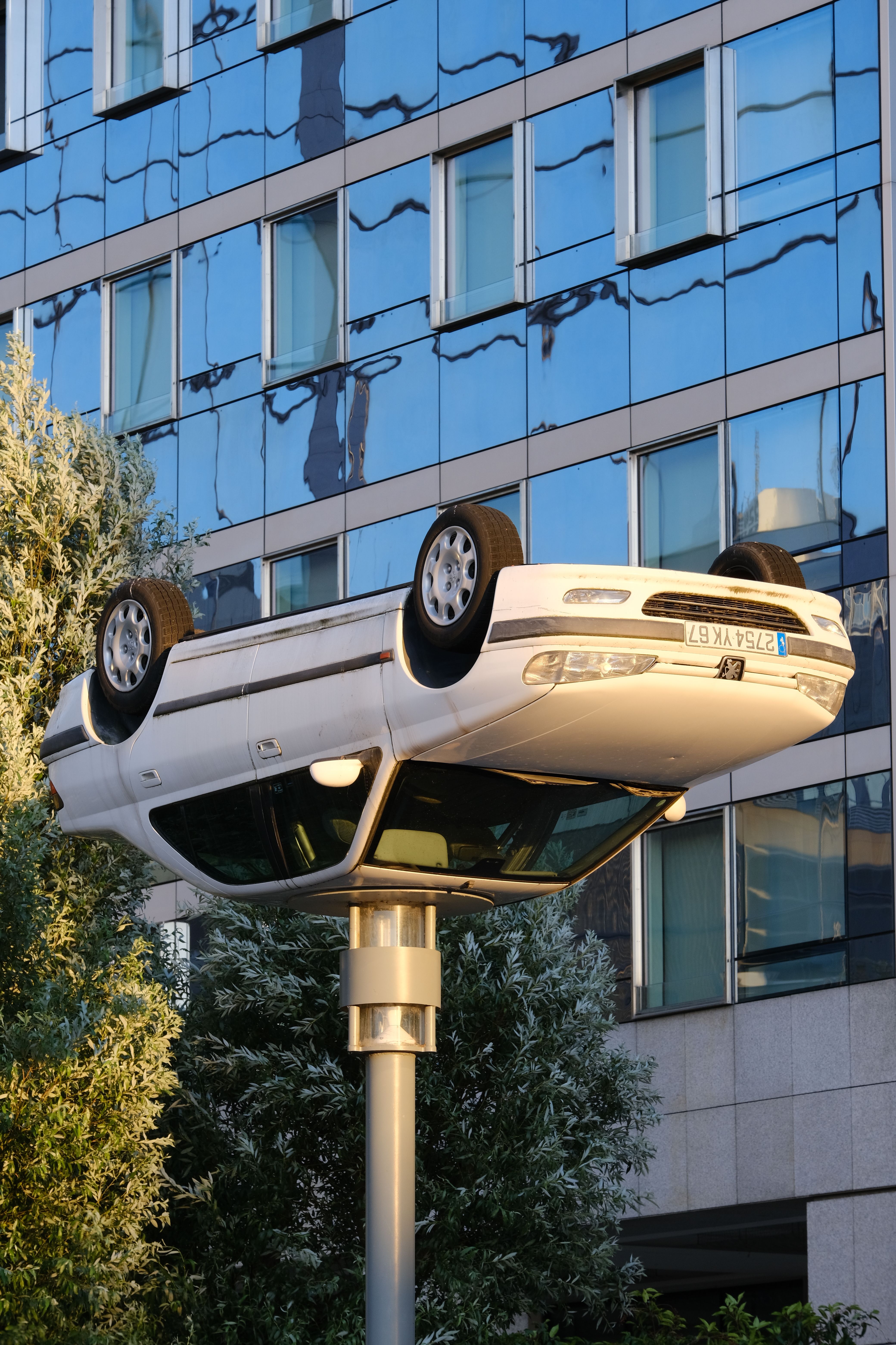 Upside-Down Car Art Installation in Urban Setting · Free Stock Photo