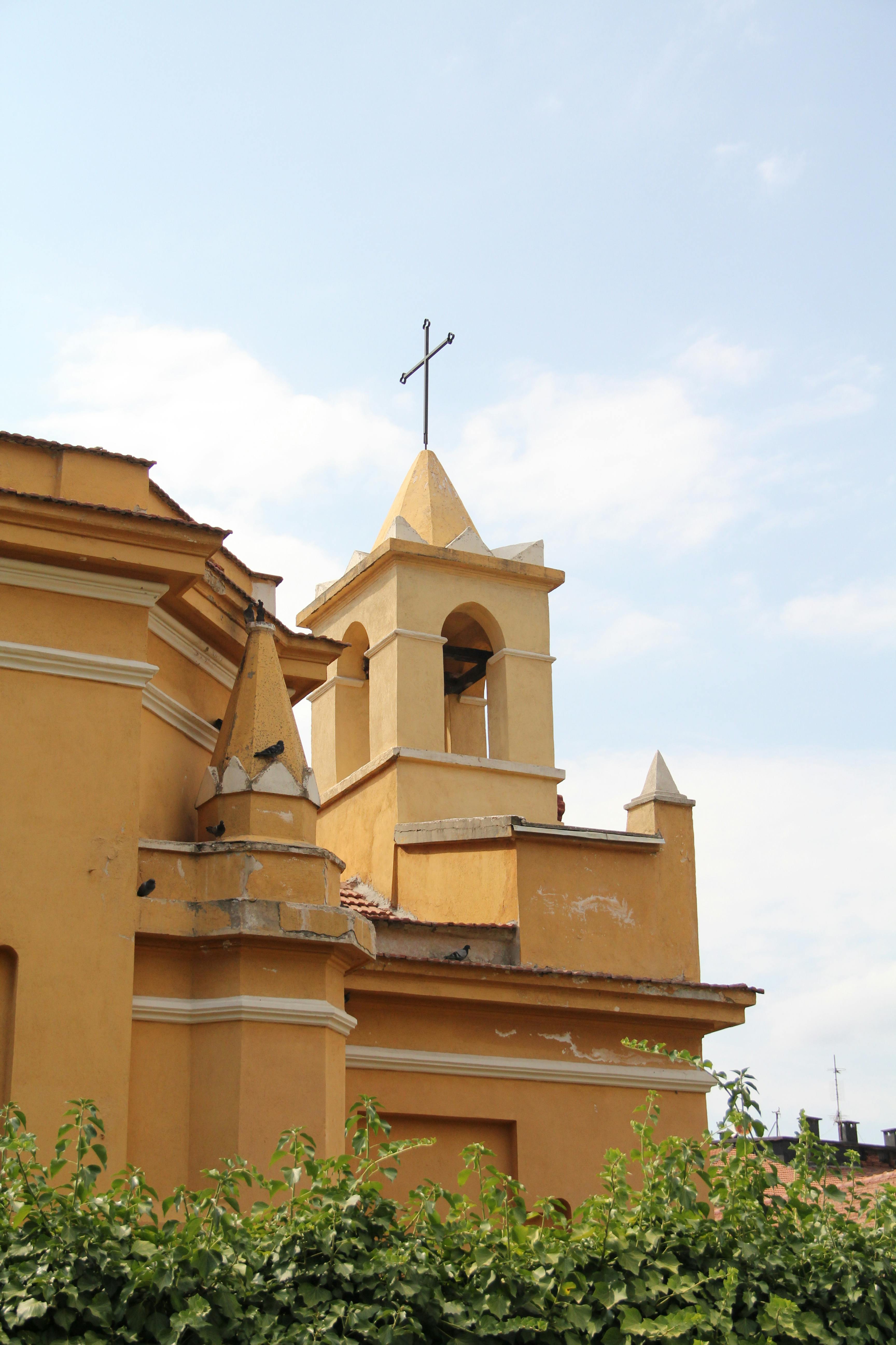 Historic Yellow Church Tower Against Blue Sky · Free Stock Photo