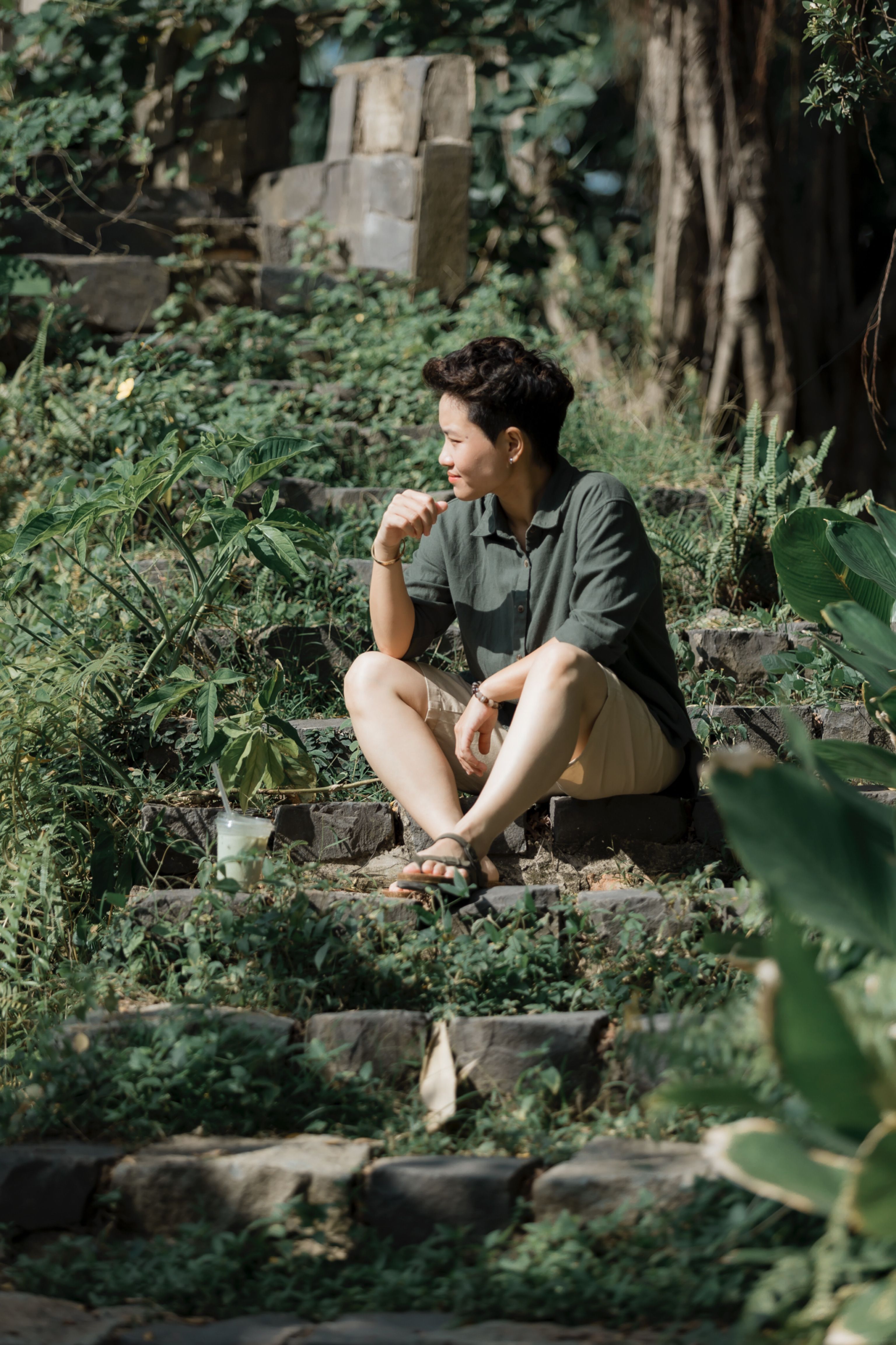 Person Relaxing on Stone Steps Surrounded by Nature · Free Stock Photo