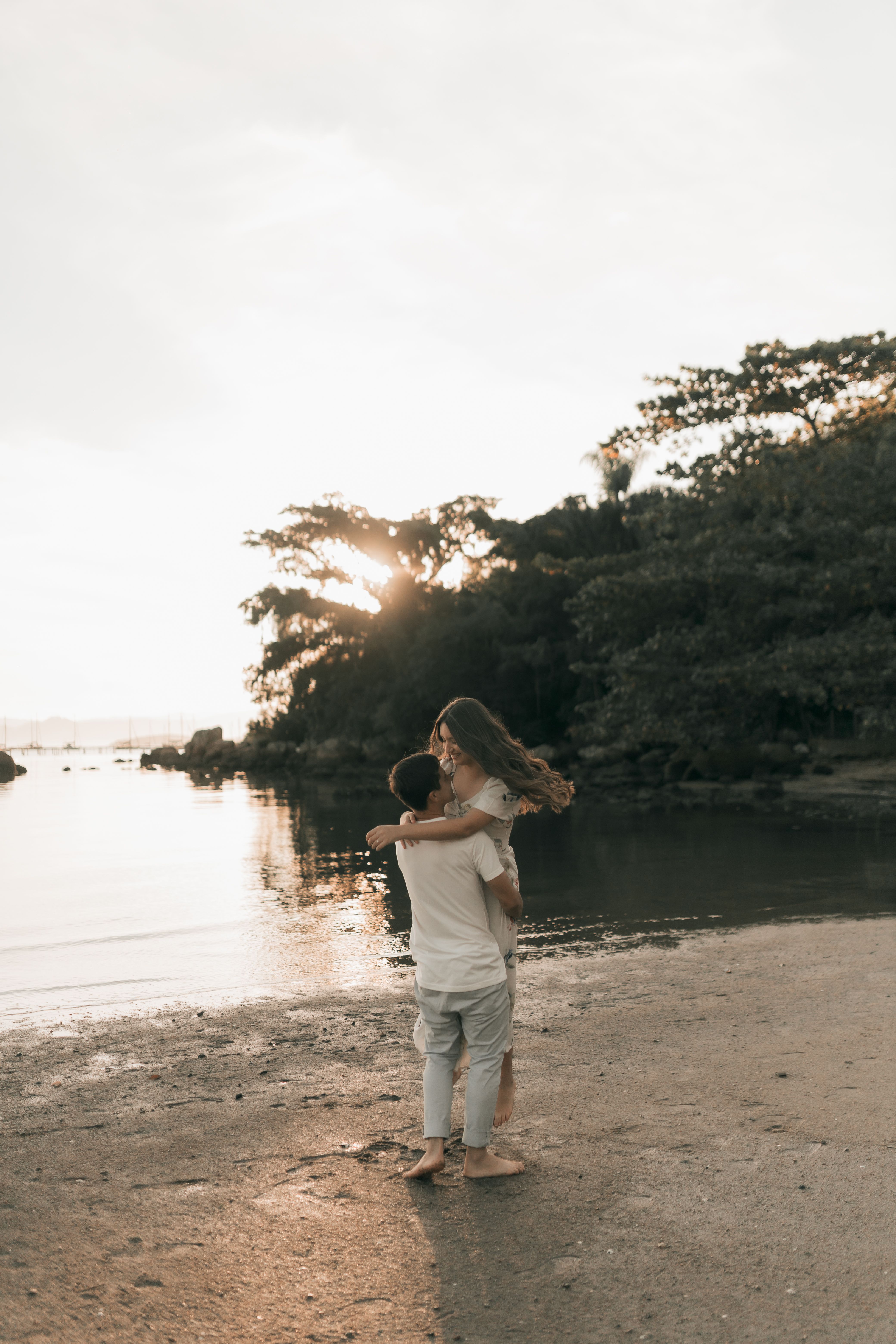 Romantic Couple Embracing on a Scenic Beach · Free Stock Photo