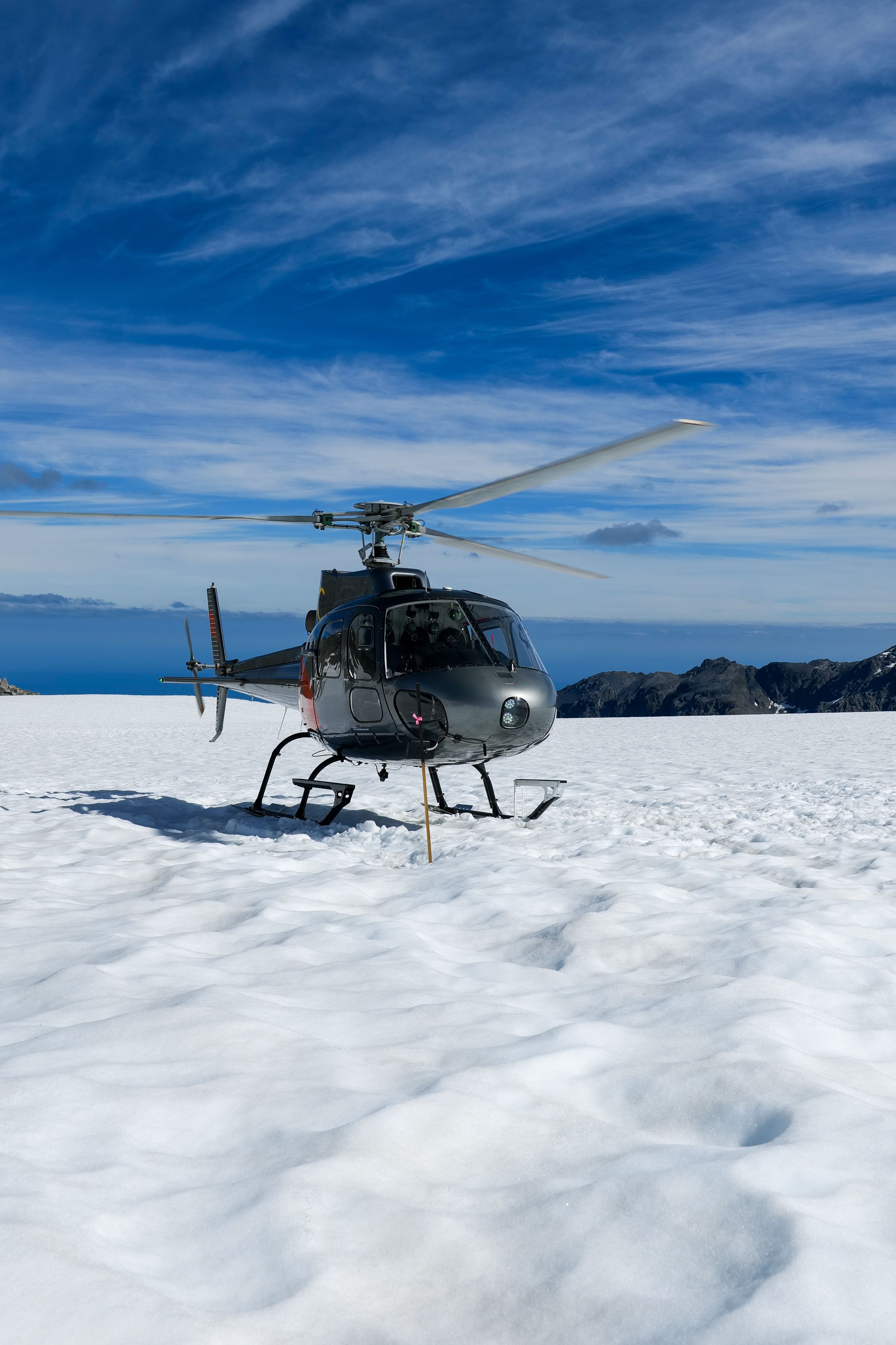 Helicopter Landing on Snow-Covered Mountain · Free Stock Photo
