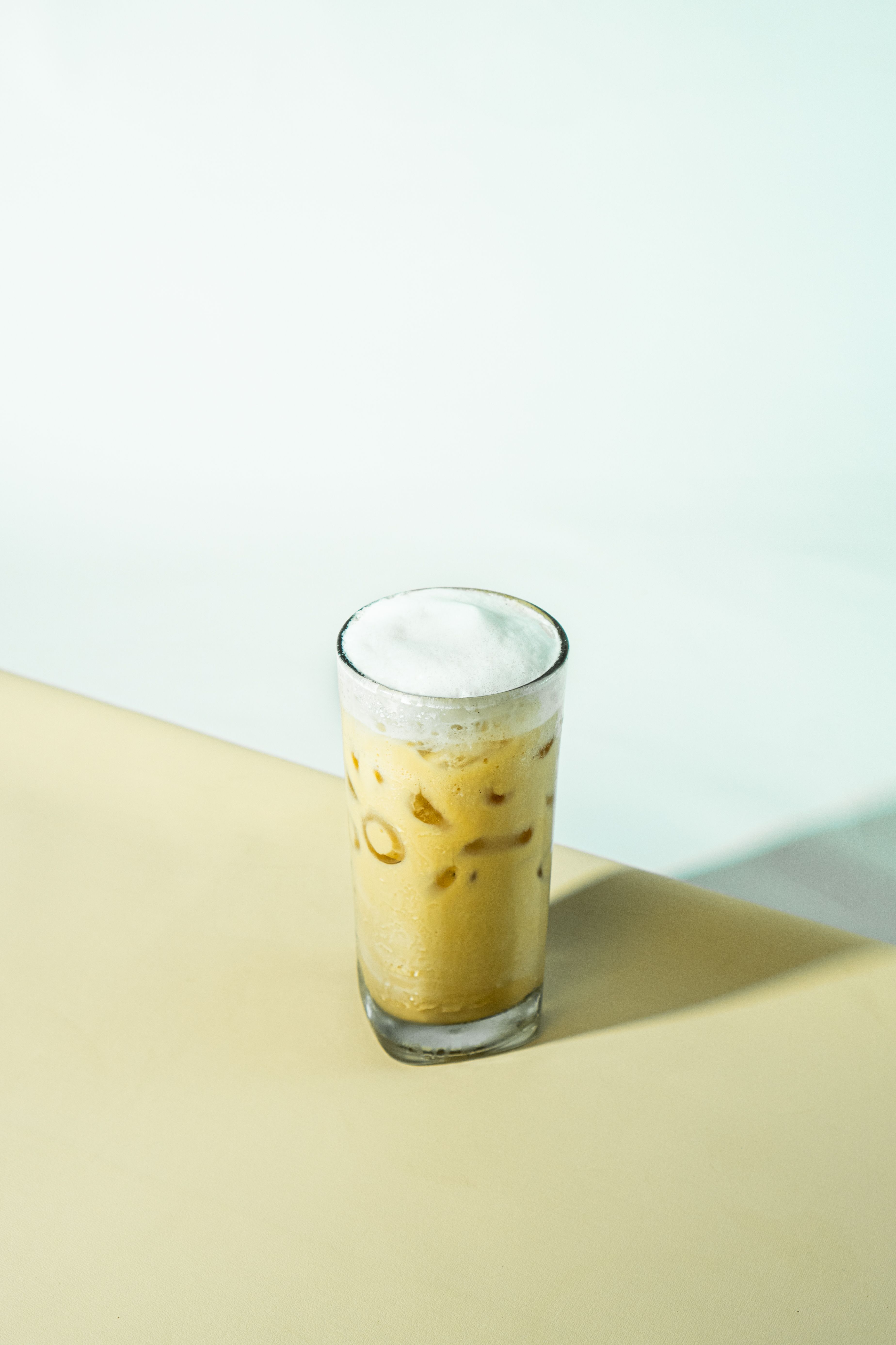 Minimalist Iced Coffee on Beige Background · Free Stock Photo