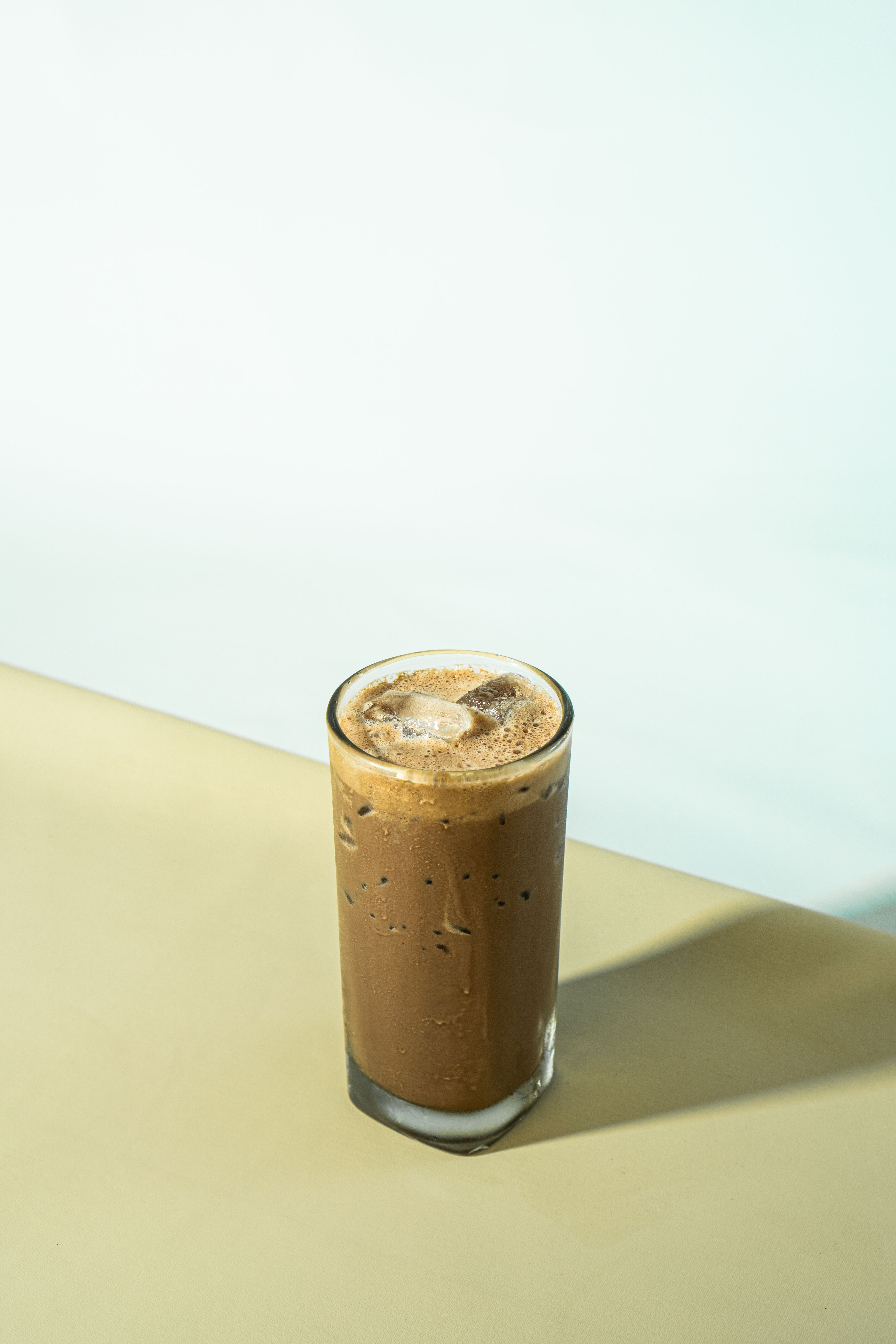 Refreshing Iced Coffee on Beige Surface · Free Stock Photo