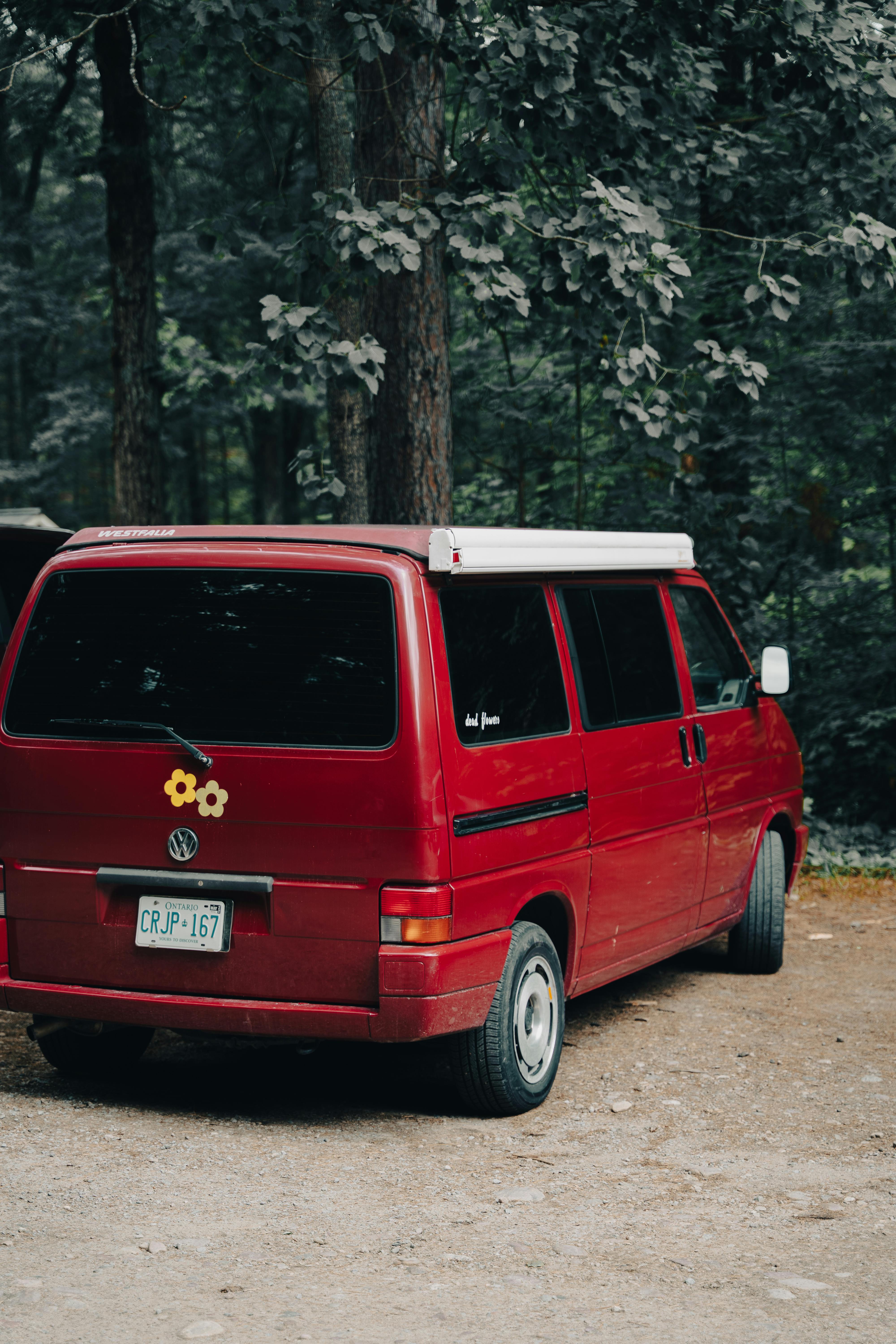 Red Camper Van in Forested Campsite · Free Stock Photo