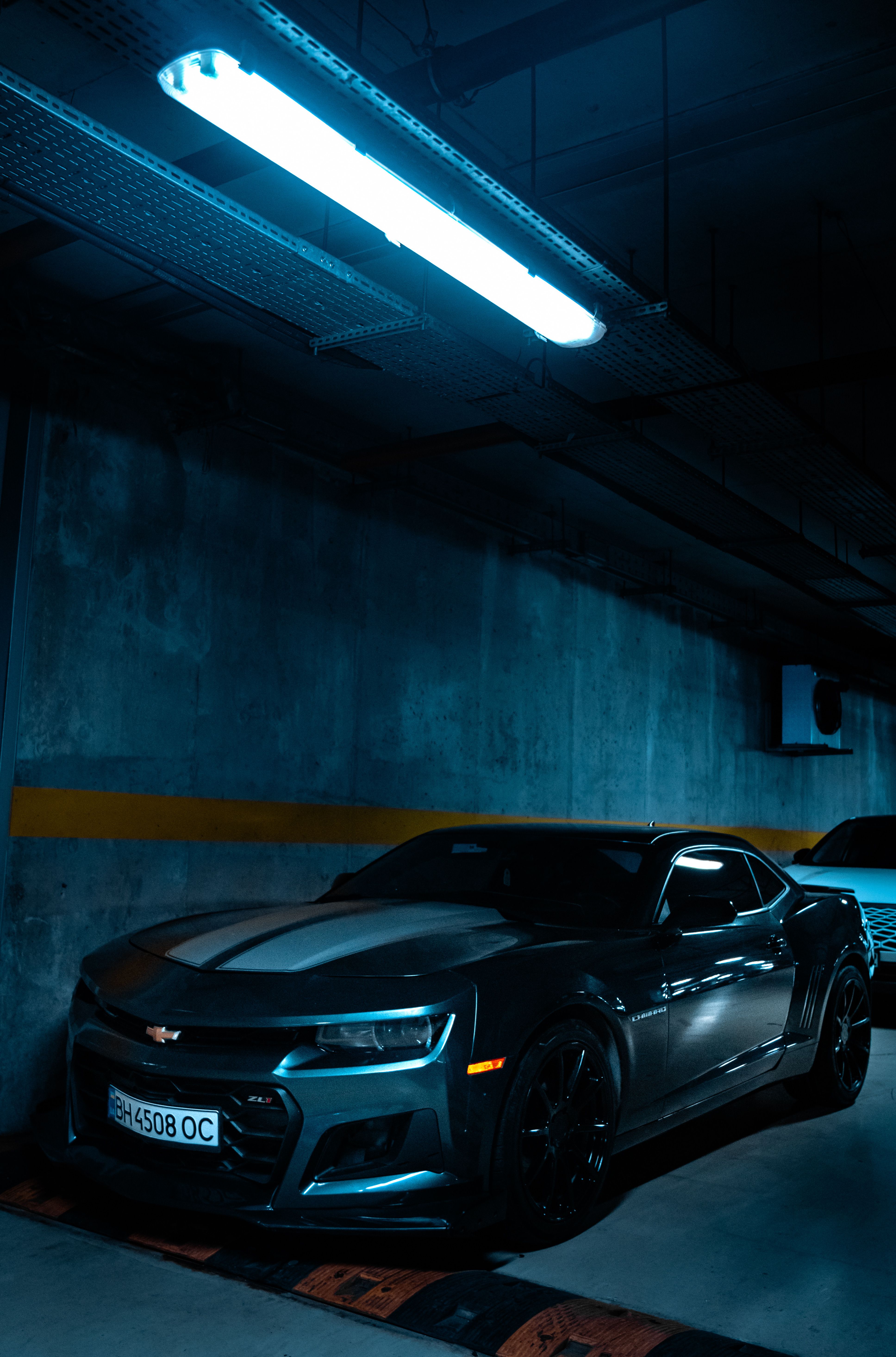 Sleek Sports Car Parked in Dimly Lit Garage · Free Stock Photo