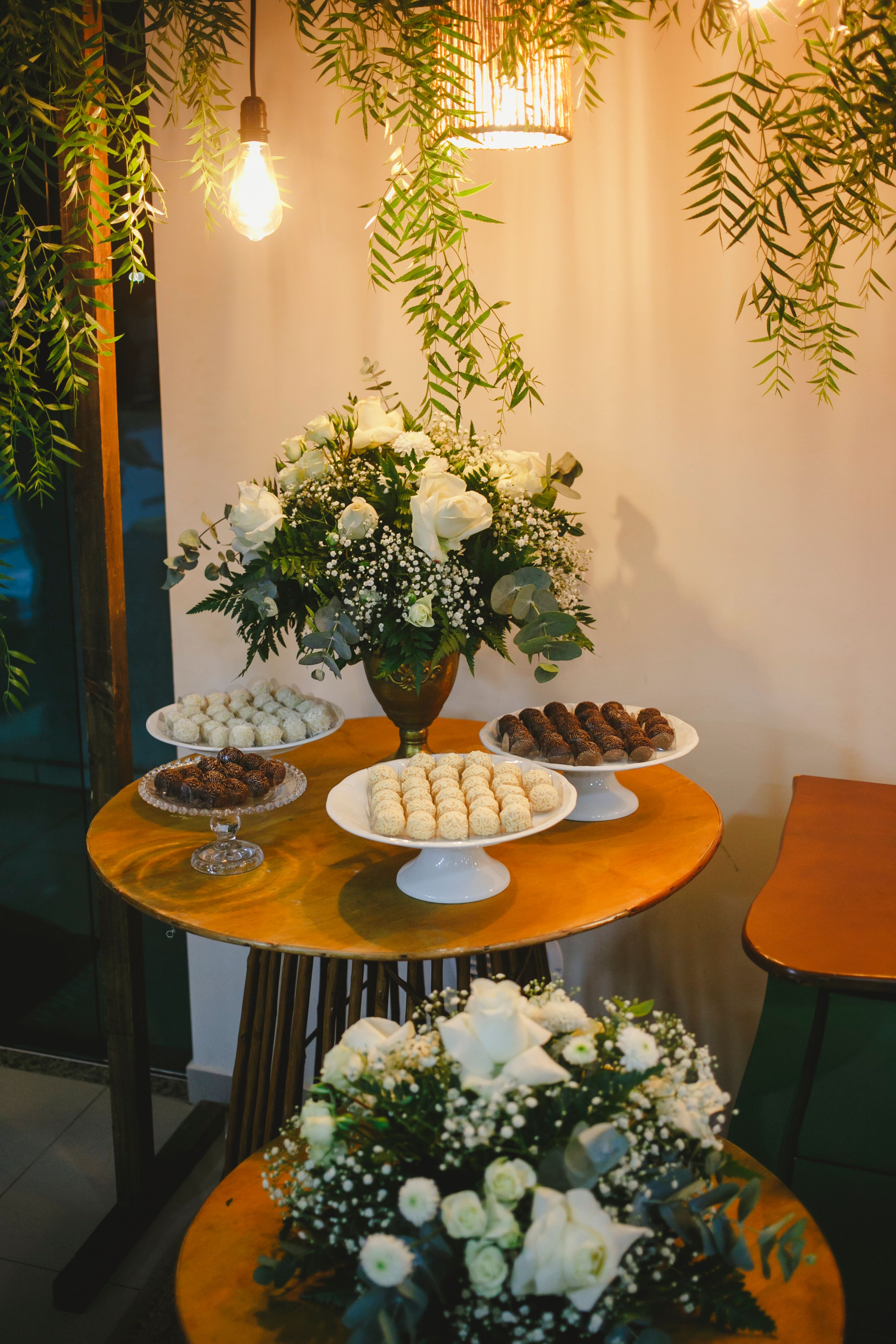 Elegant Floral Dessert Table with Ambient Lighting · Free Stock Photo