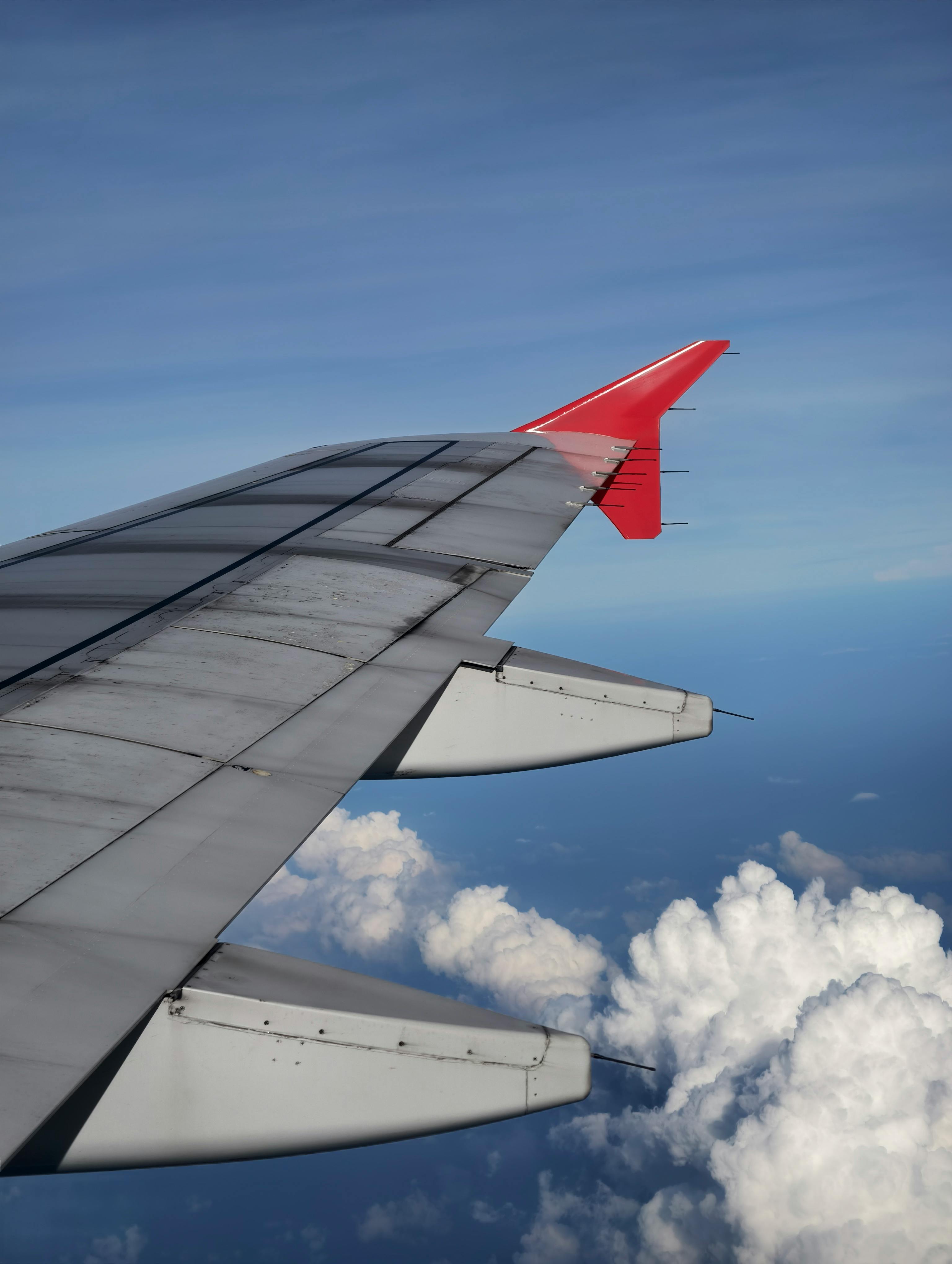 Airplane Wing in Flight Above Clouds · Free Stock Photo