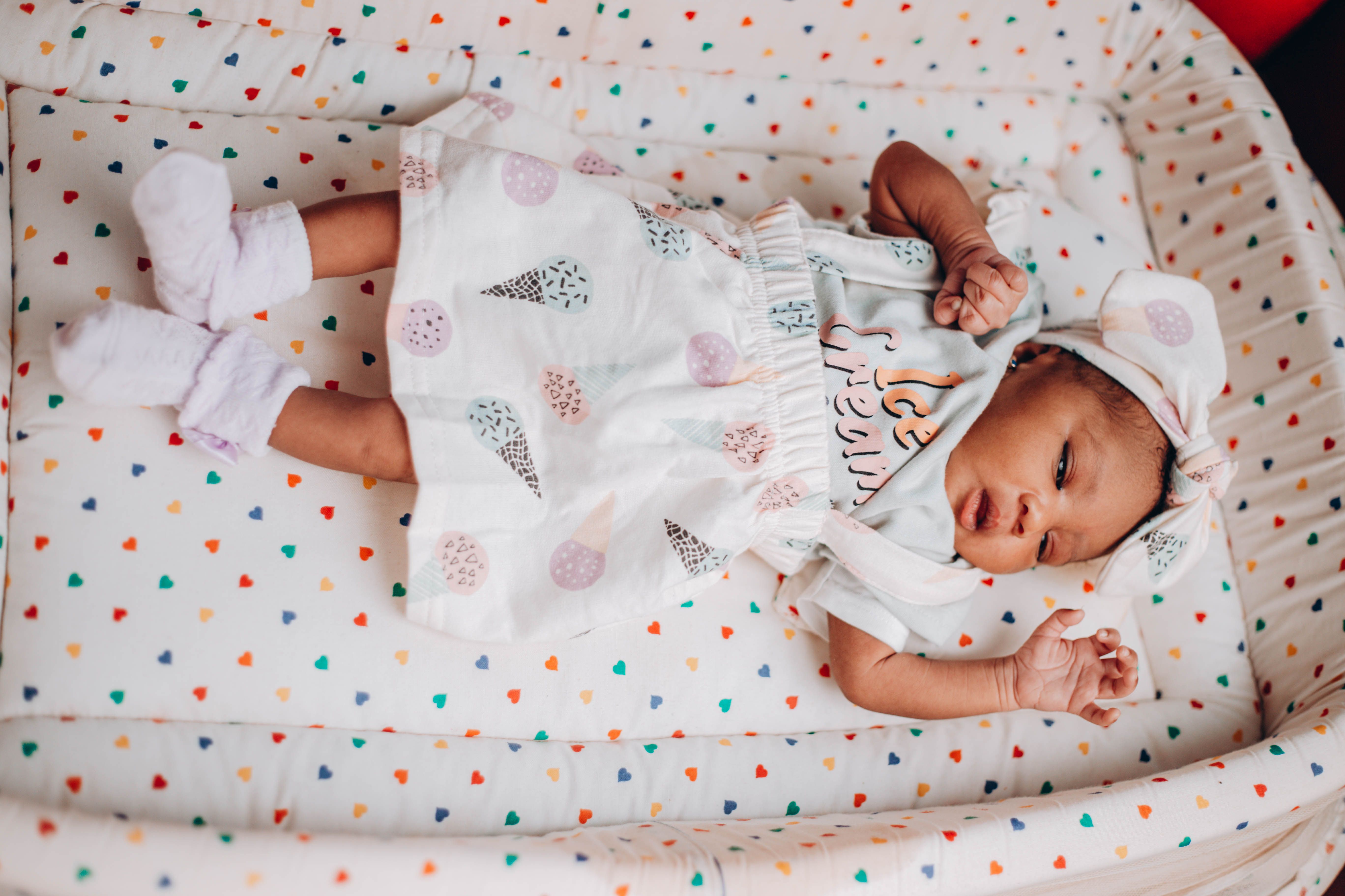 Adorable Baby in Pastel Outfit on Colorful Blanket · Free Stock Photo